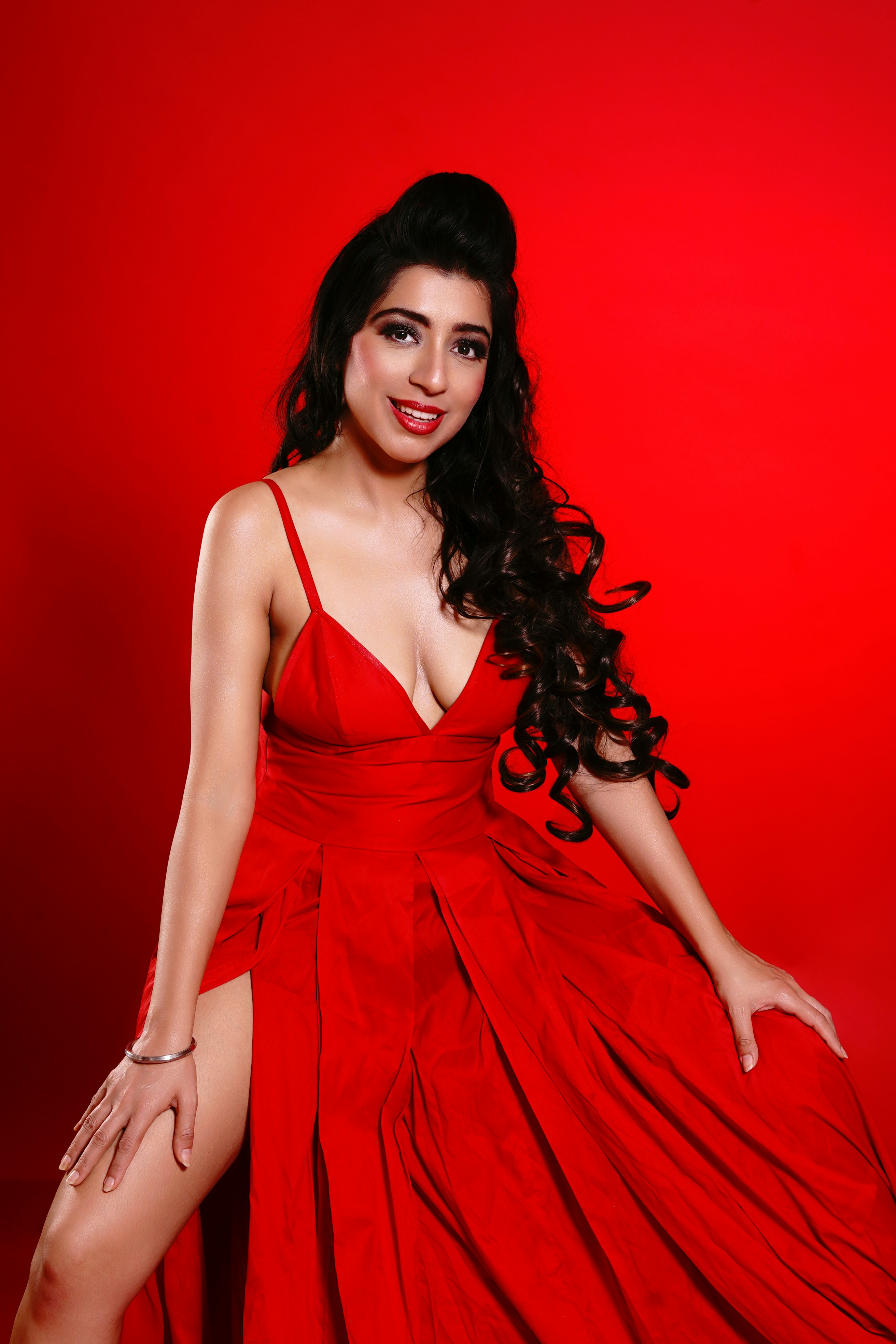 A woman in a red dress posing for a picture photo – Free Mumbai Image on Unsplash