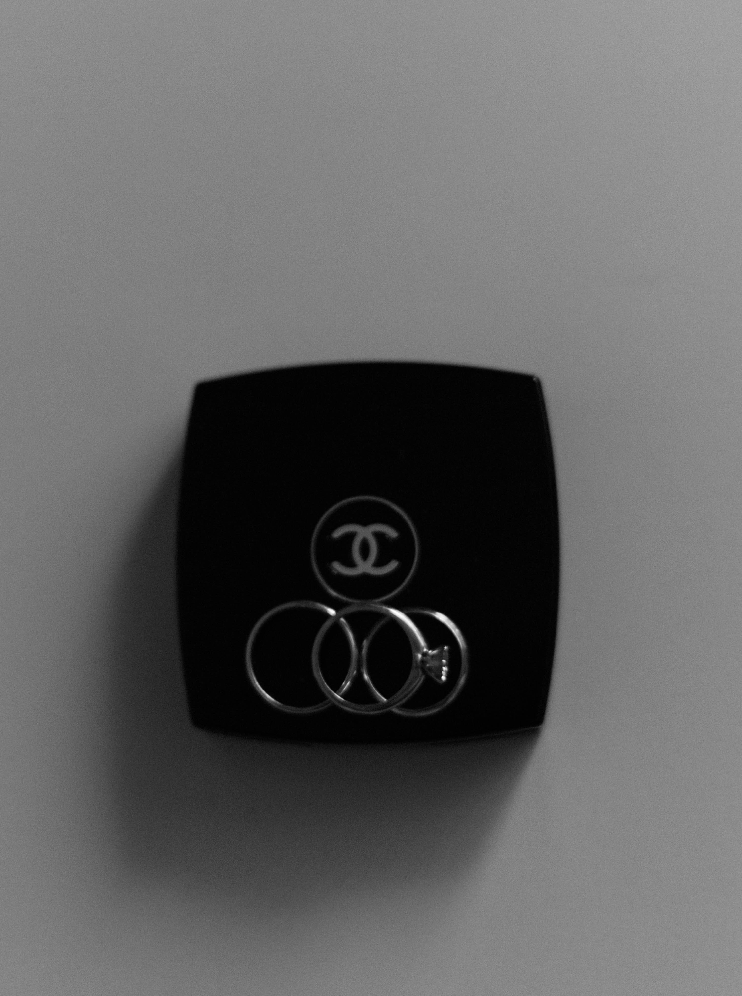 Monochrome Emblem: Chanel Box and Intertwined Rings as Quiet Still Life
