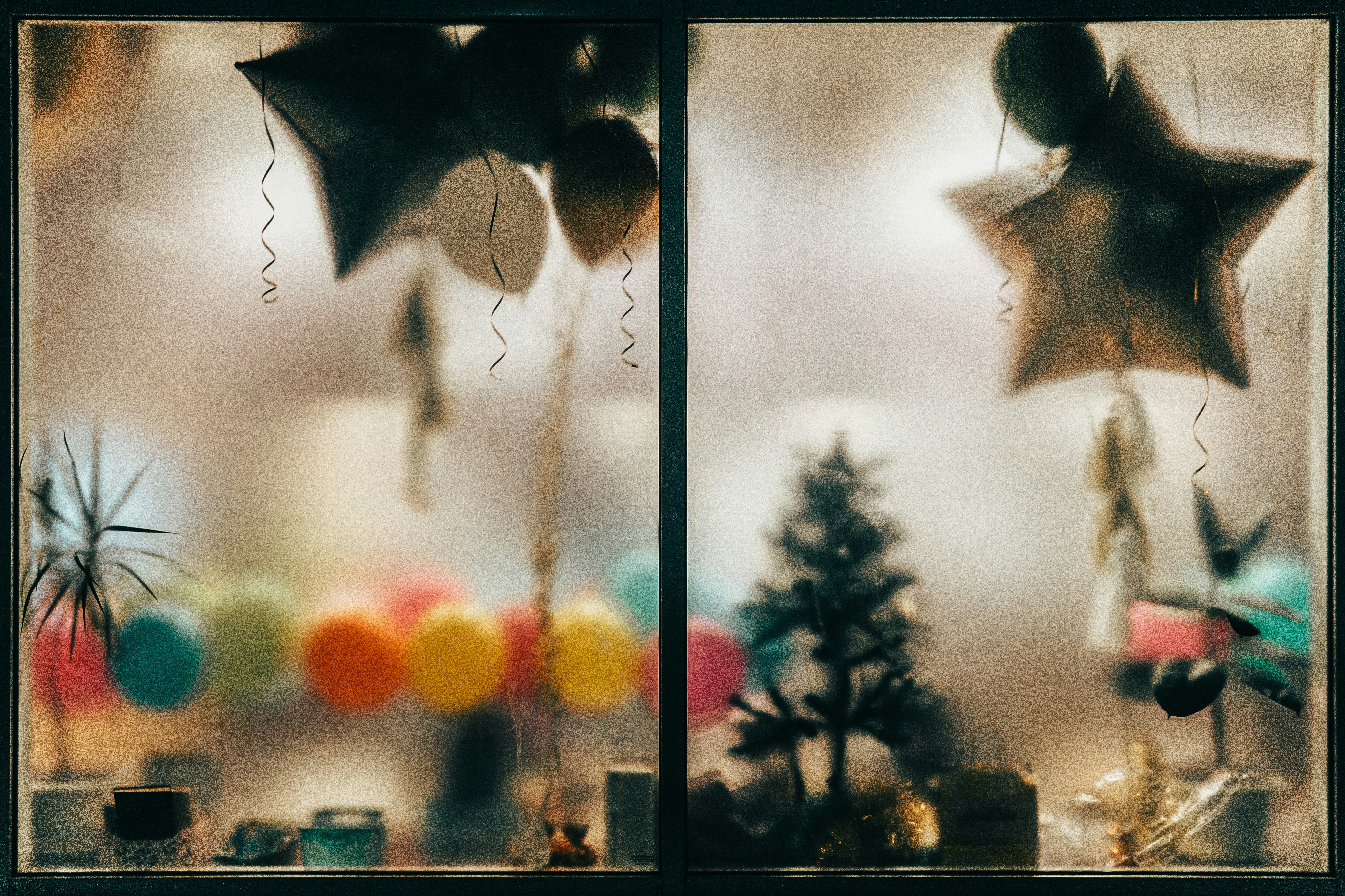 Through Frosted Glass: Balloons, Stars, and a Tiny Tree in Holiday Glow