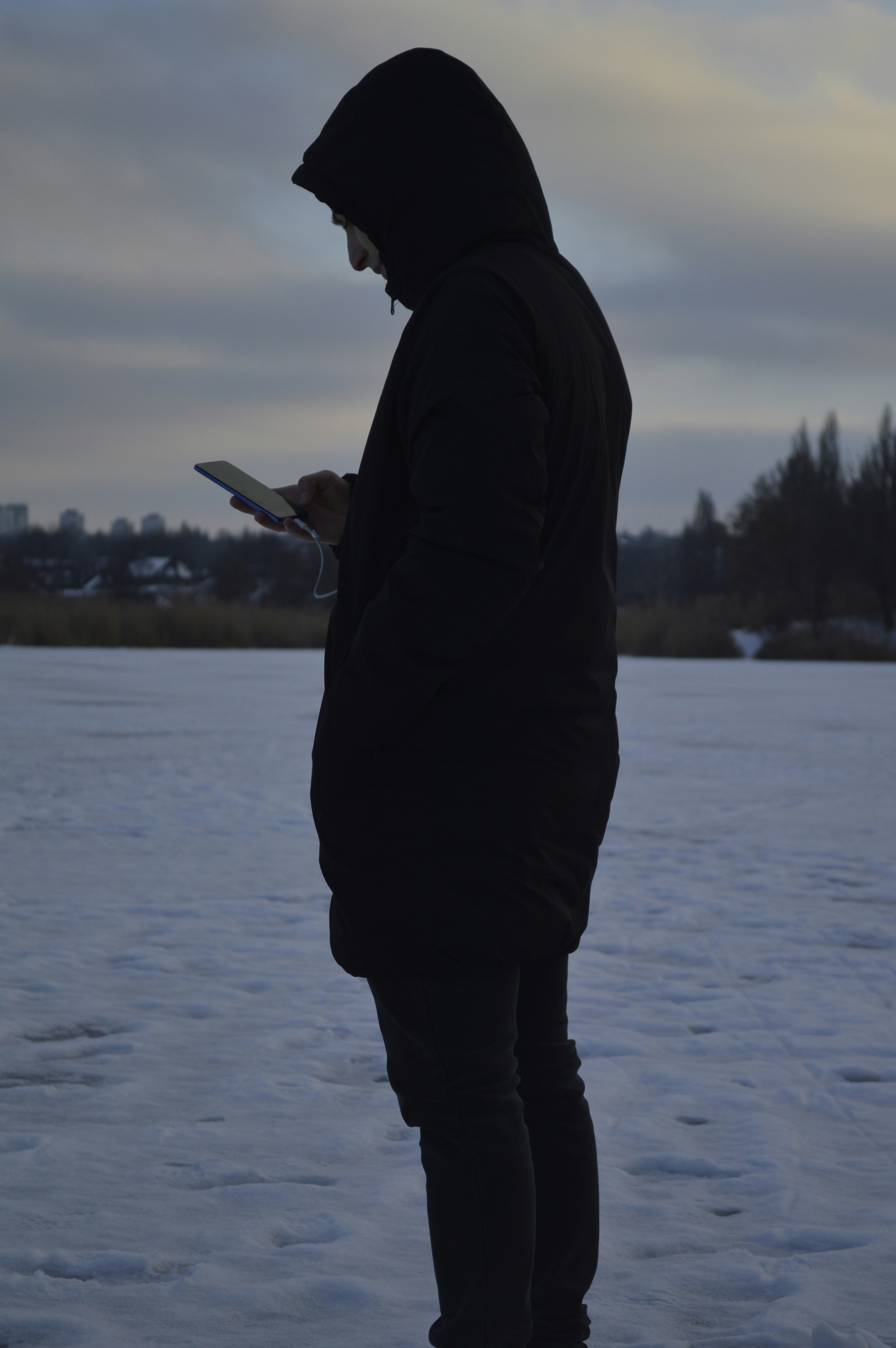 Silhouette in Winter: A Quiet Moment with a Phone