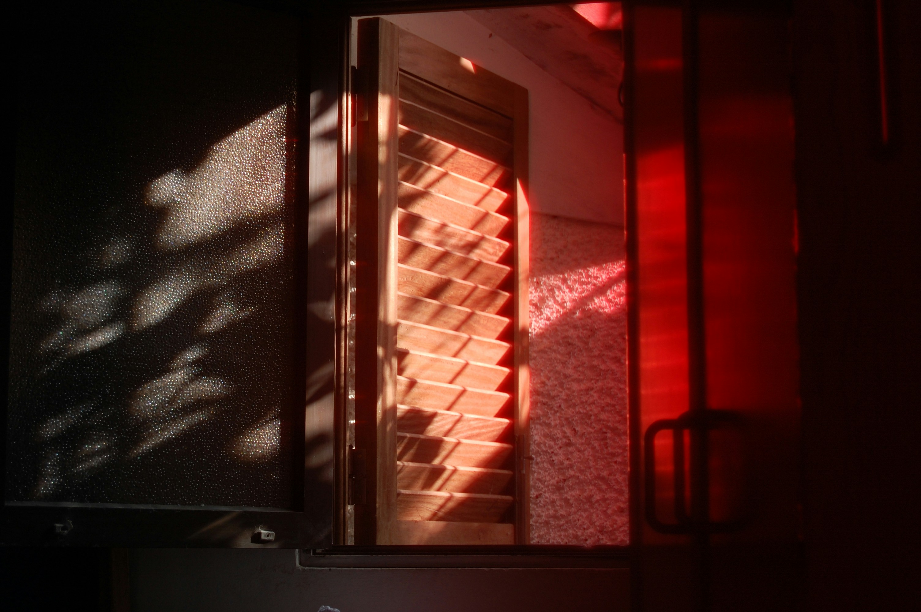 Crimson Slats Under a Quiet Industrial Glow