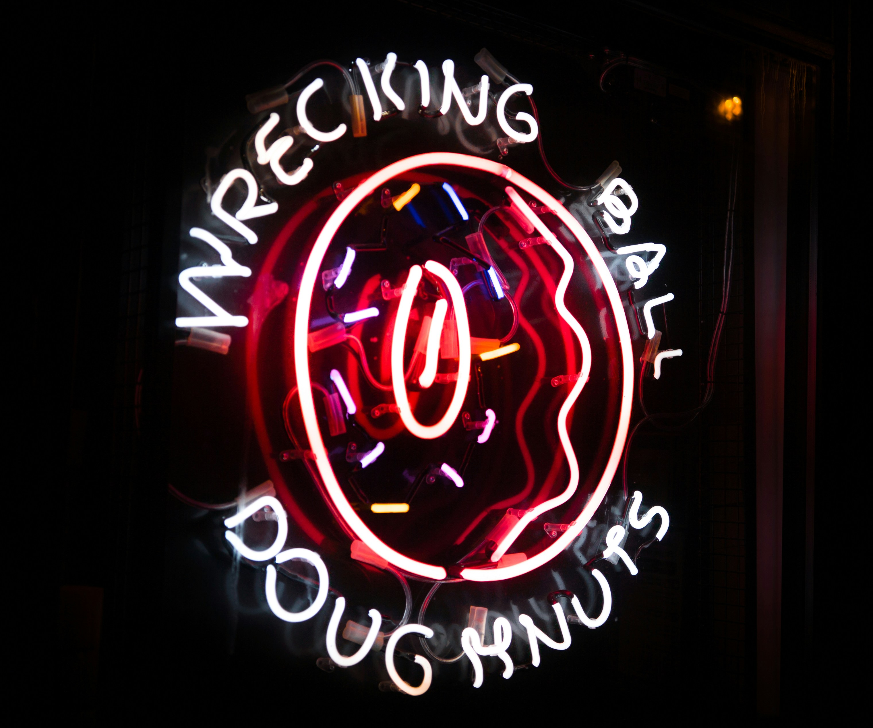 A neon sign that says wreck doughnuts photo – Free Dundee Image on Unsplash