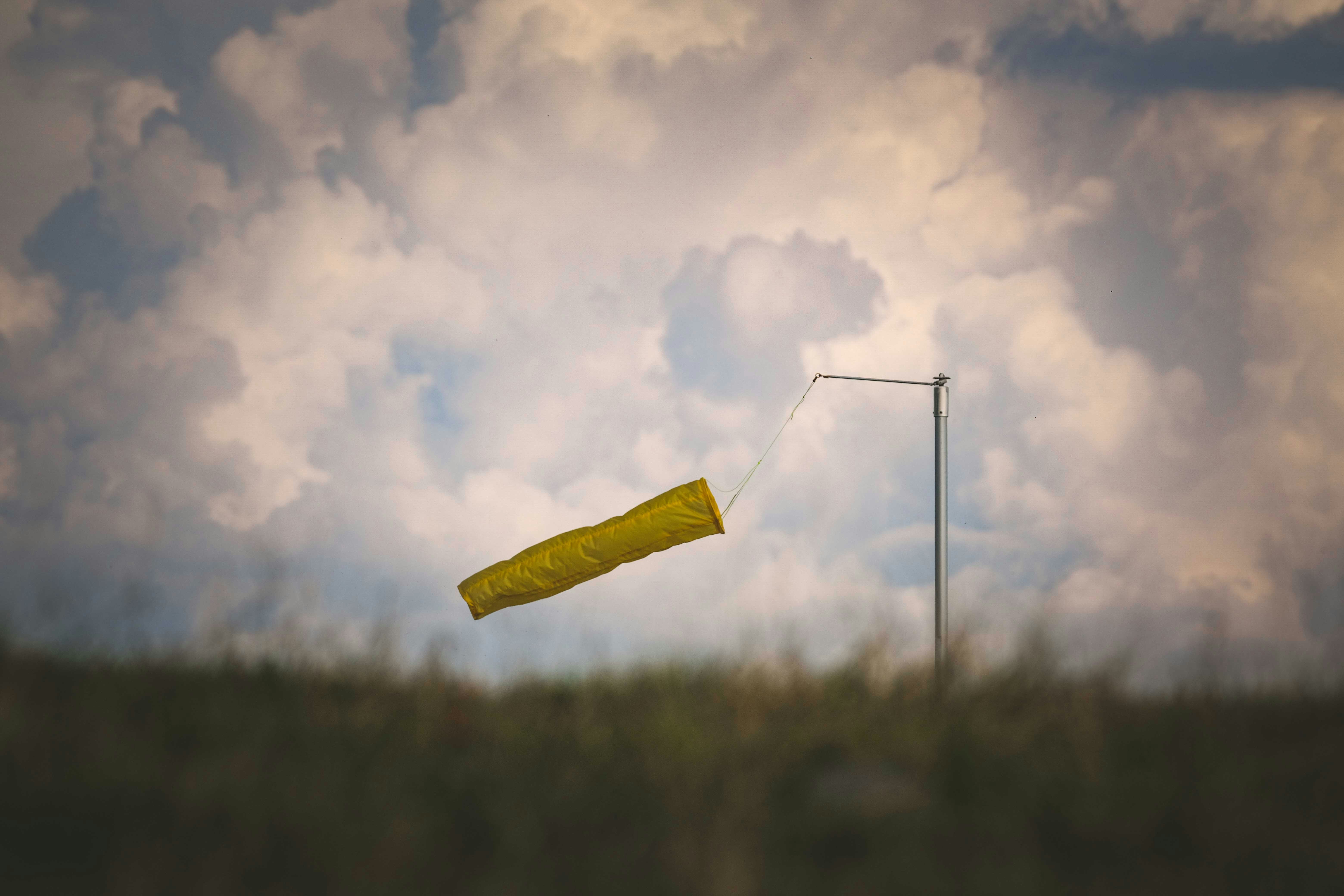 A yellow kite flying in a cloudy sky photo – Free Grey Image on Unsplash