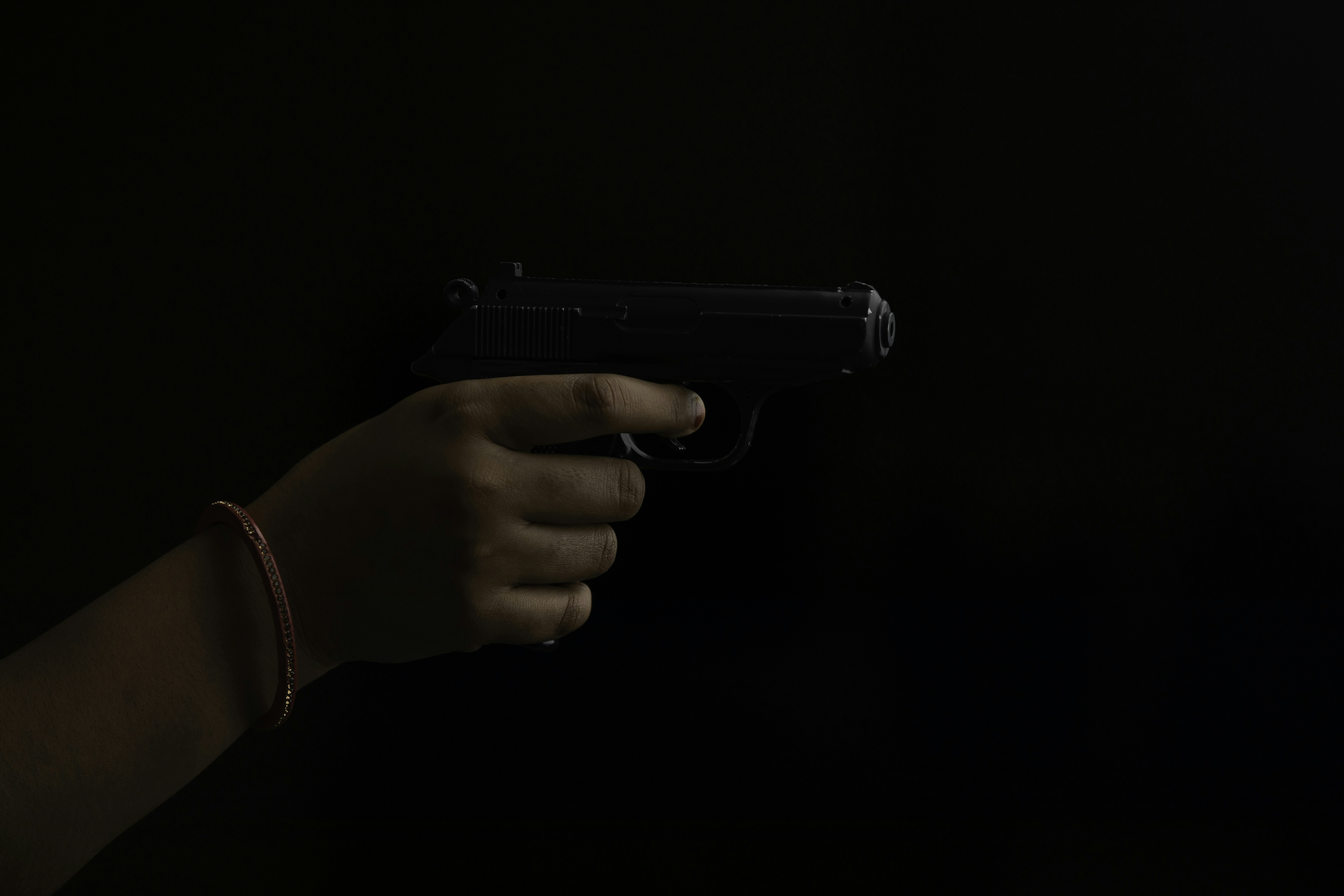 A hand holding a gun in the dark photo – Free Weapon Image on Unsplash