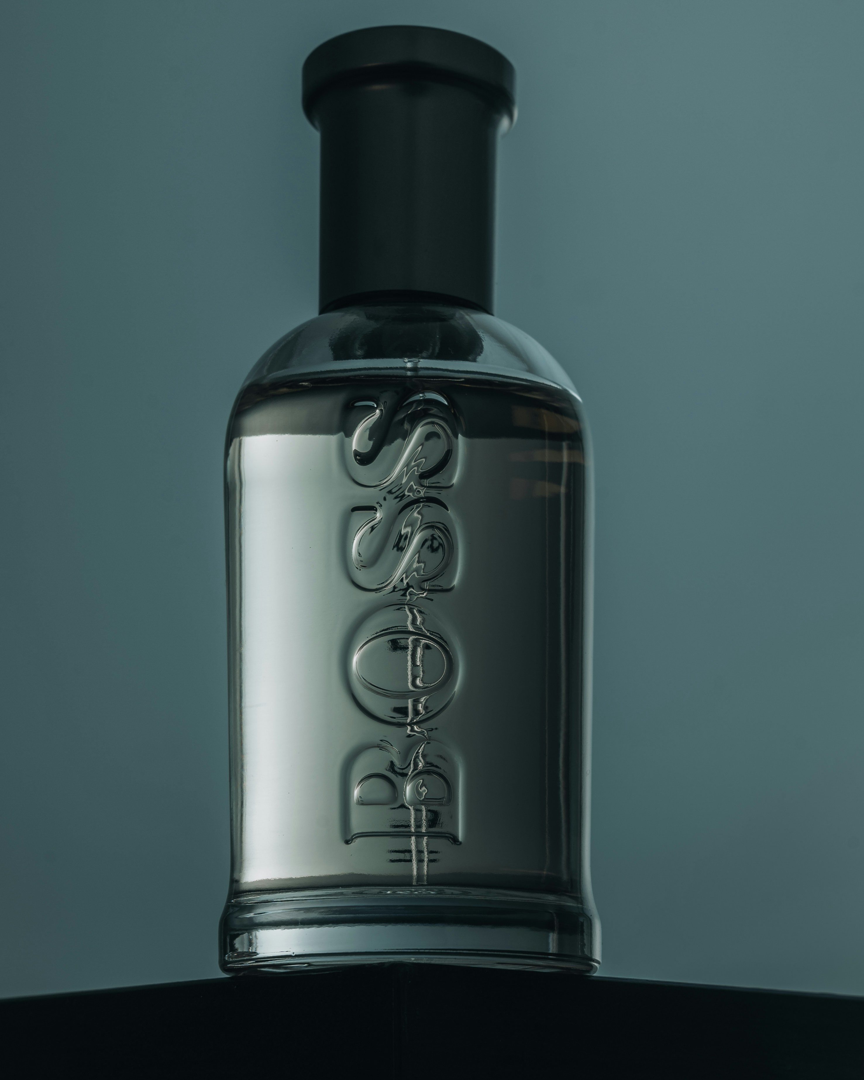 A bottle of cologne sitting on top of a table photo – Free Photography ...