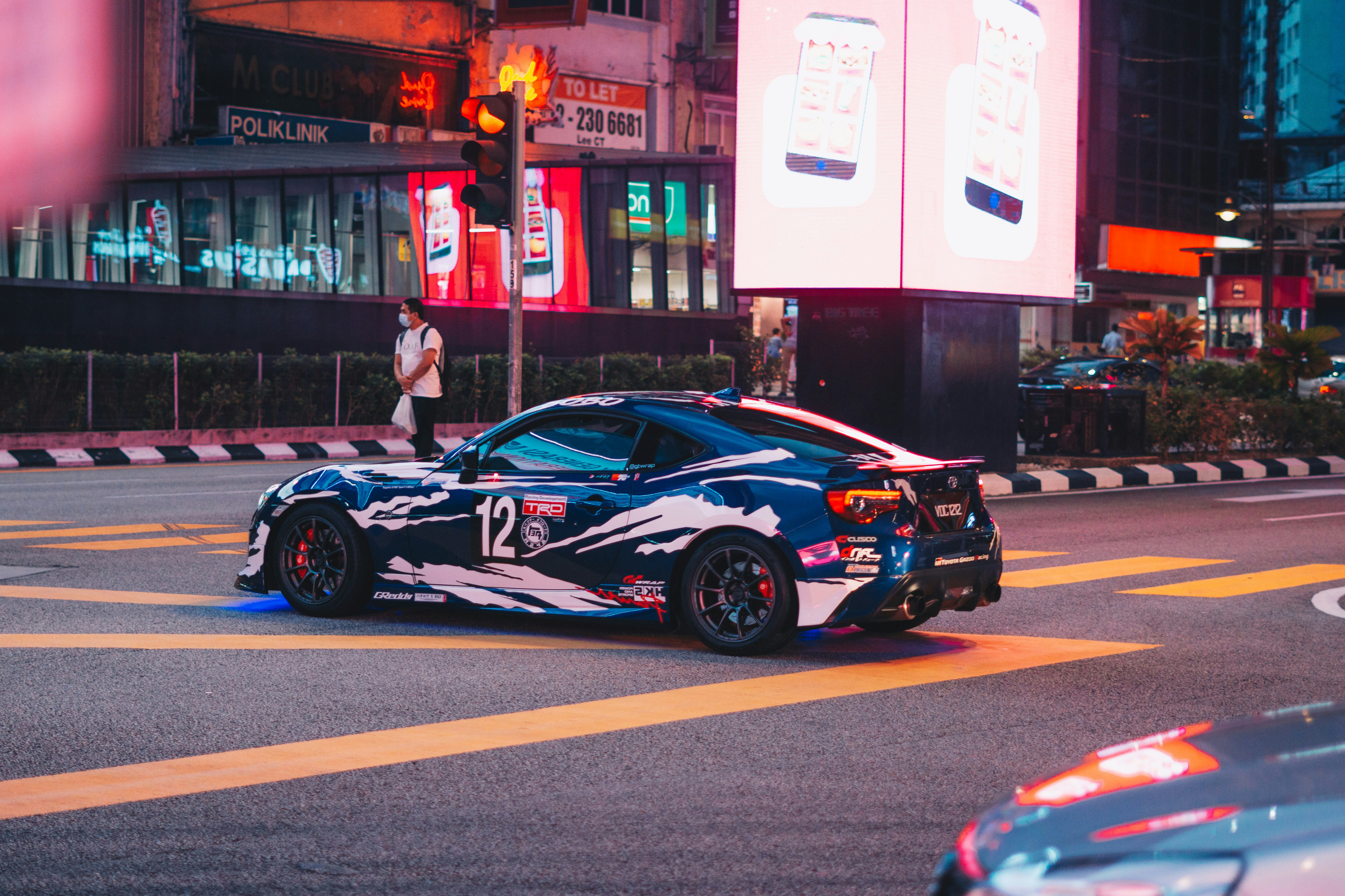 Neon Run: Blue Camouflage Racer #12 at a Neon-Drenched City Crossing