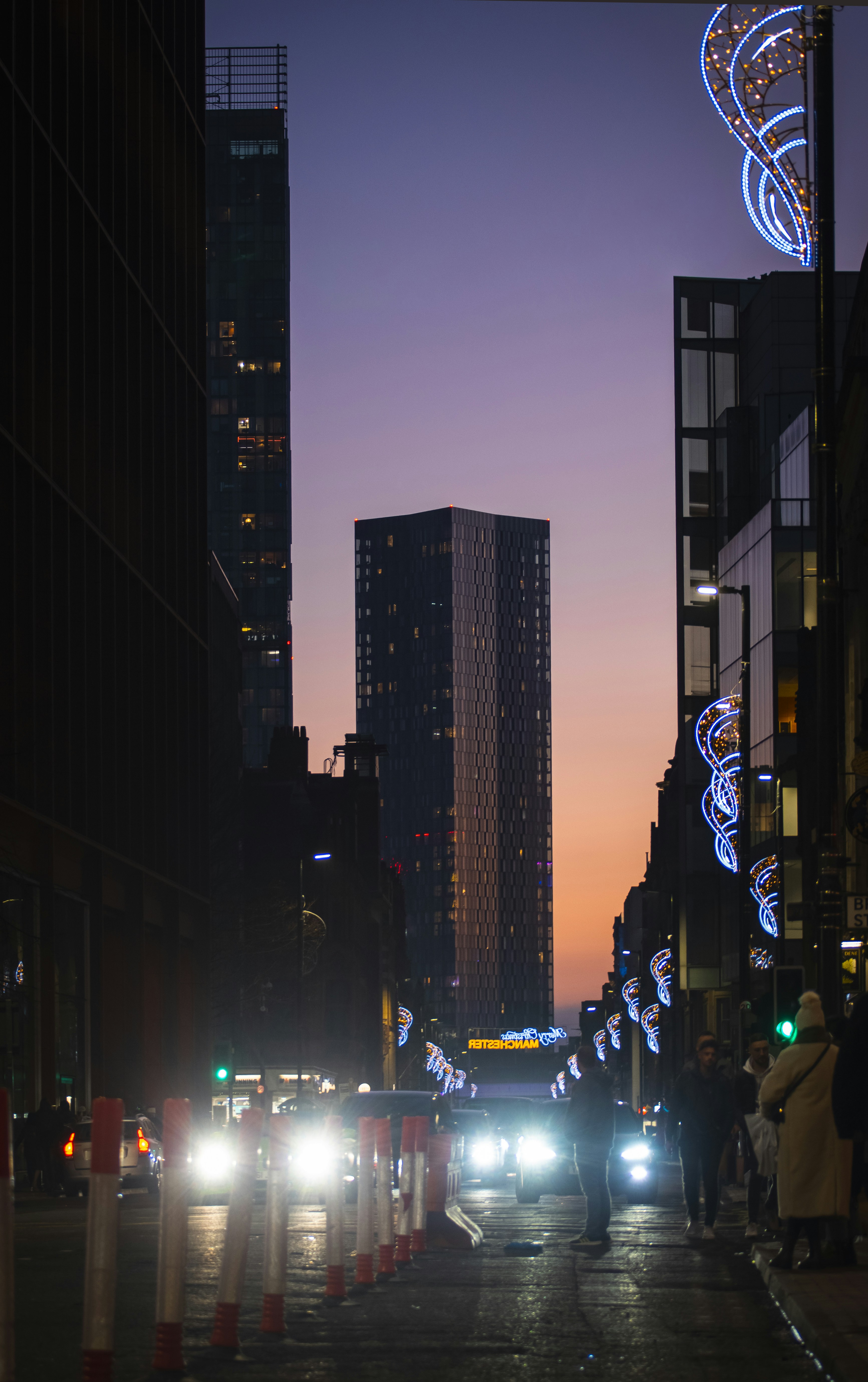 Dusk Descent: City Street Alight with Neon Snowflake Ornaments