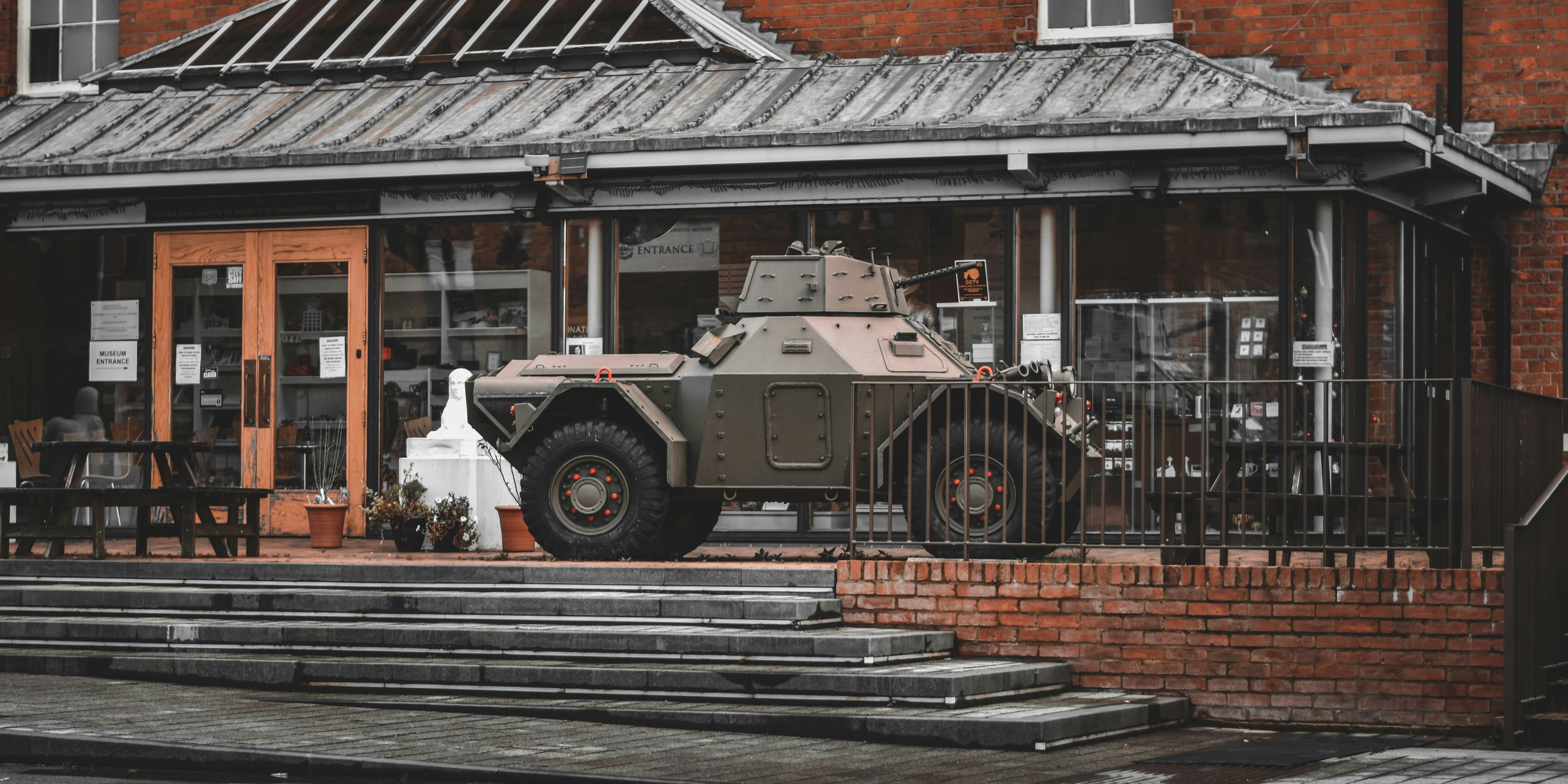 a large military vehicle parked in front of a building