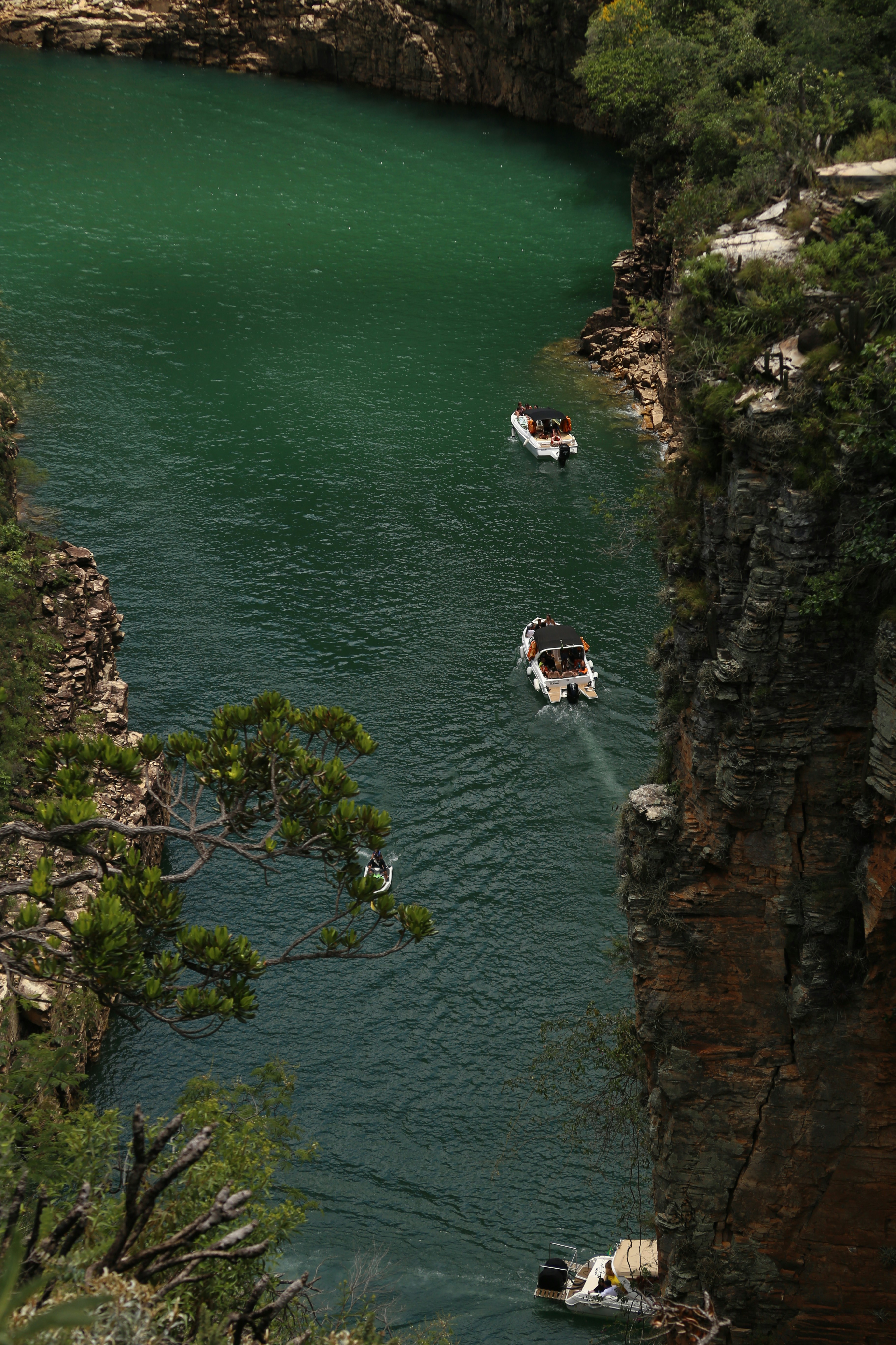 a group of boats floating on top of a river