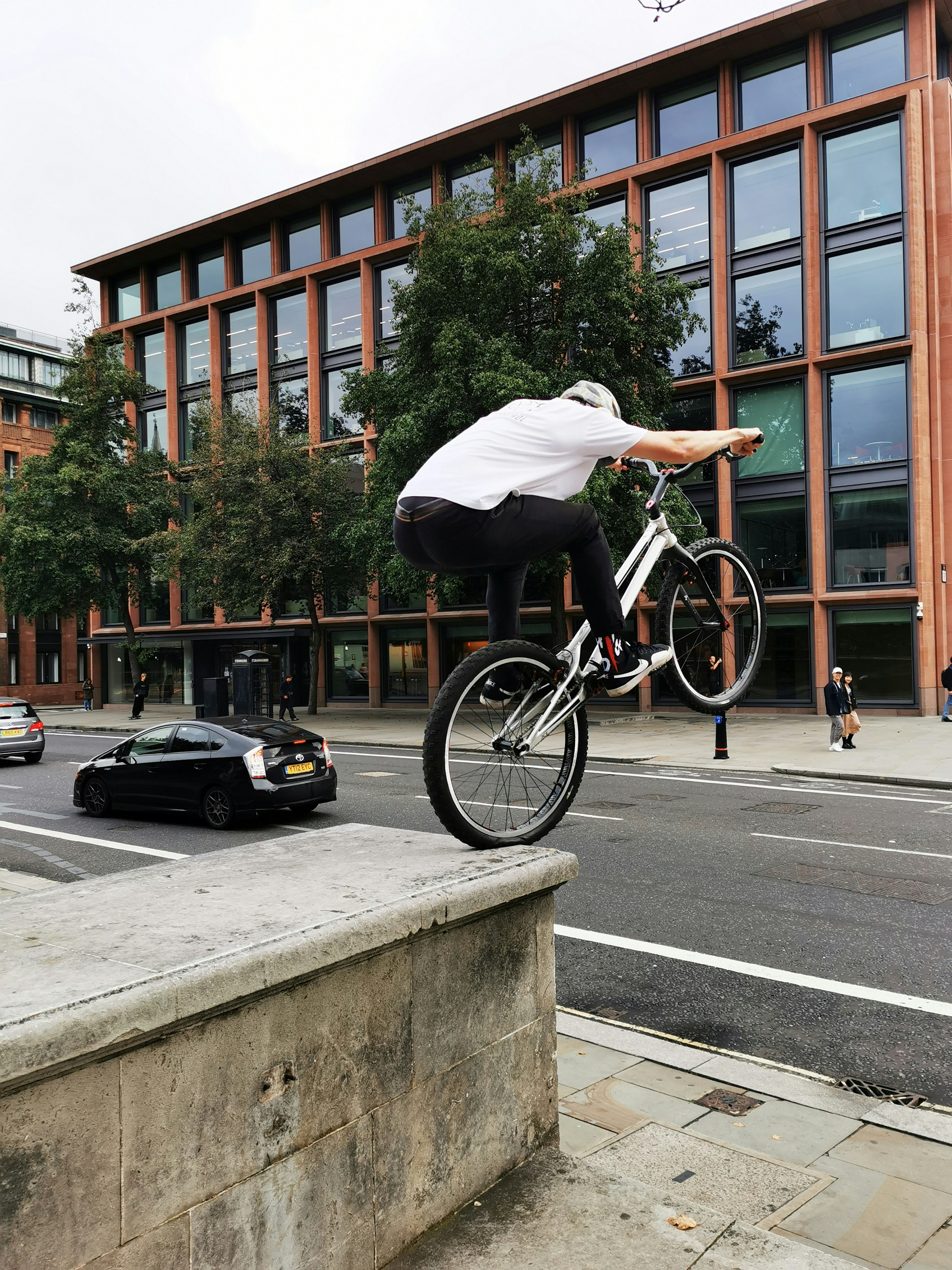 a person riding a bike on a city street