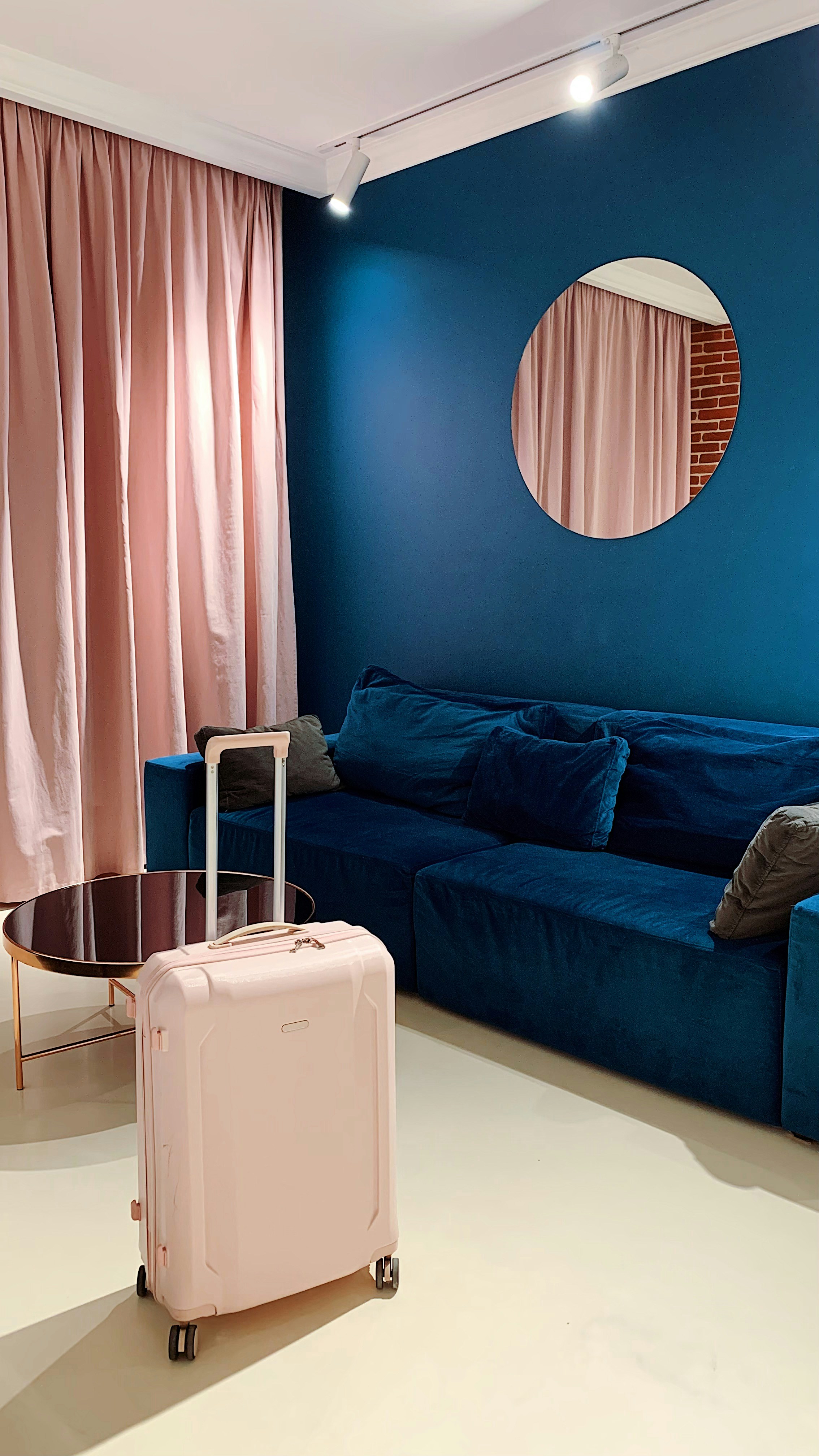 Pastel Transit: Pink Suitcase in a Velvet Teal Nook