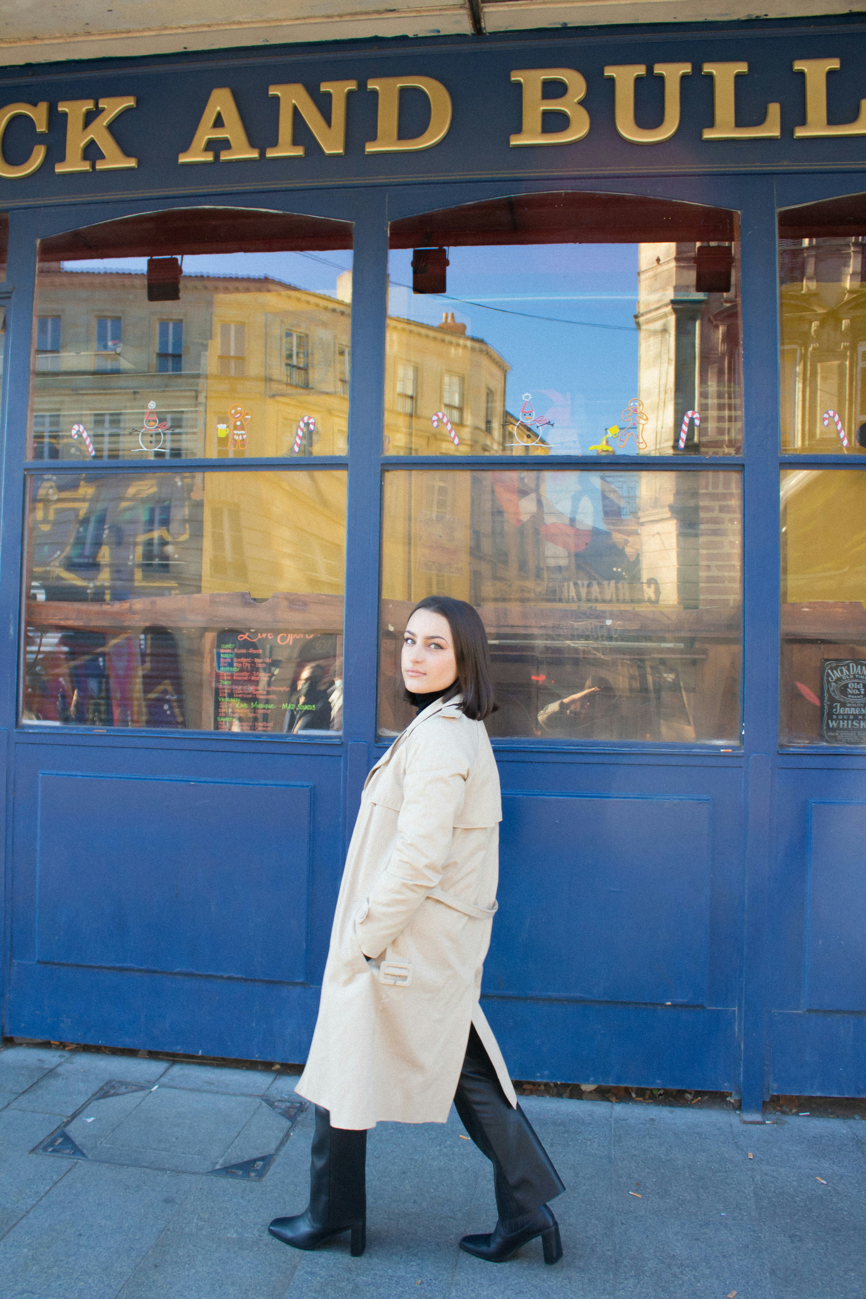 Blue Facade Portrait: A Trench-Coat Moment Before Reflective Windows