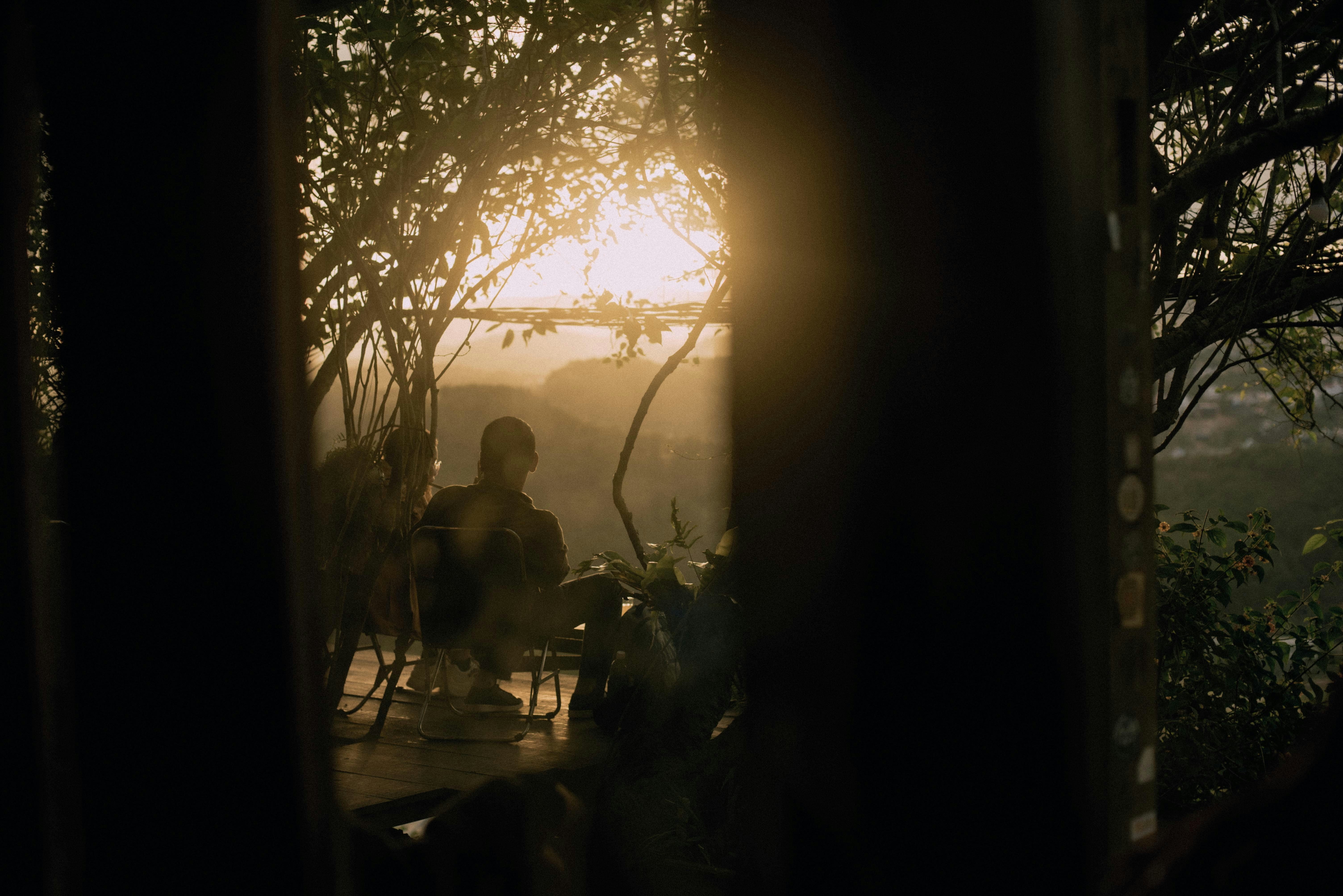 Dawn Quiet on the Veranda: A Silhouette in Warm Light