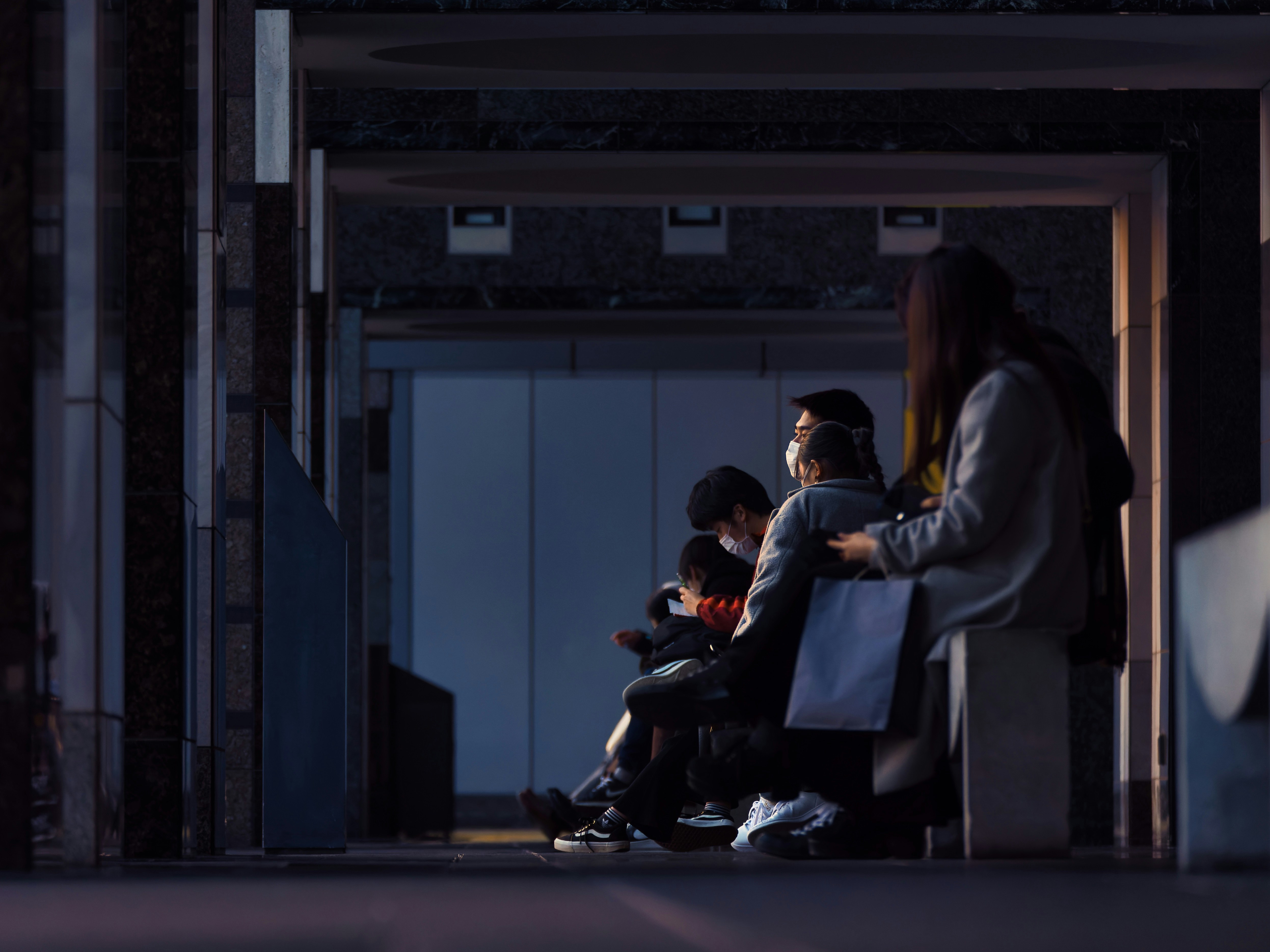 A group of people sitting next to each other photo – Free Human Image ...