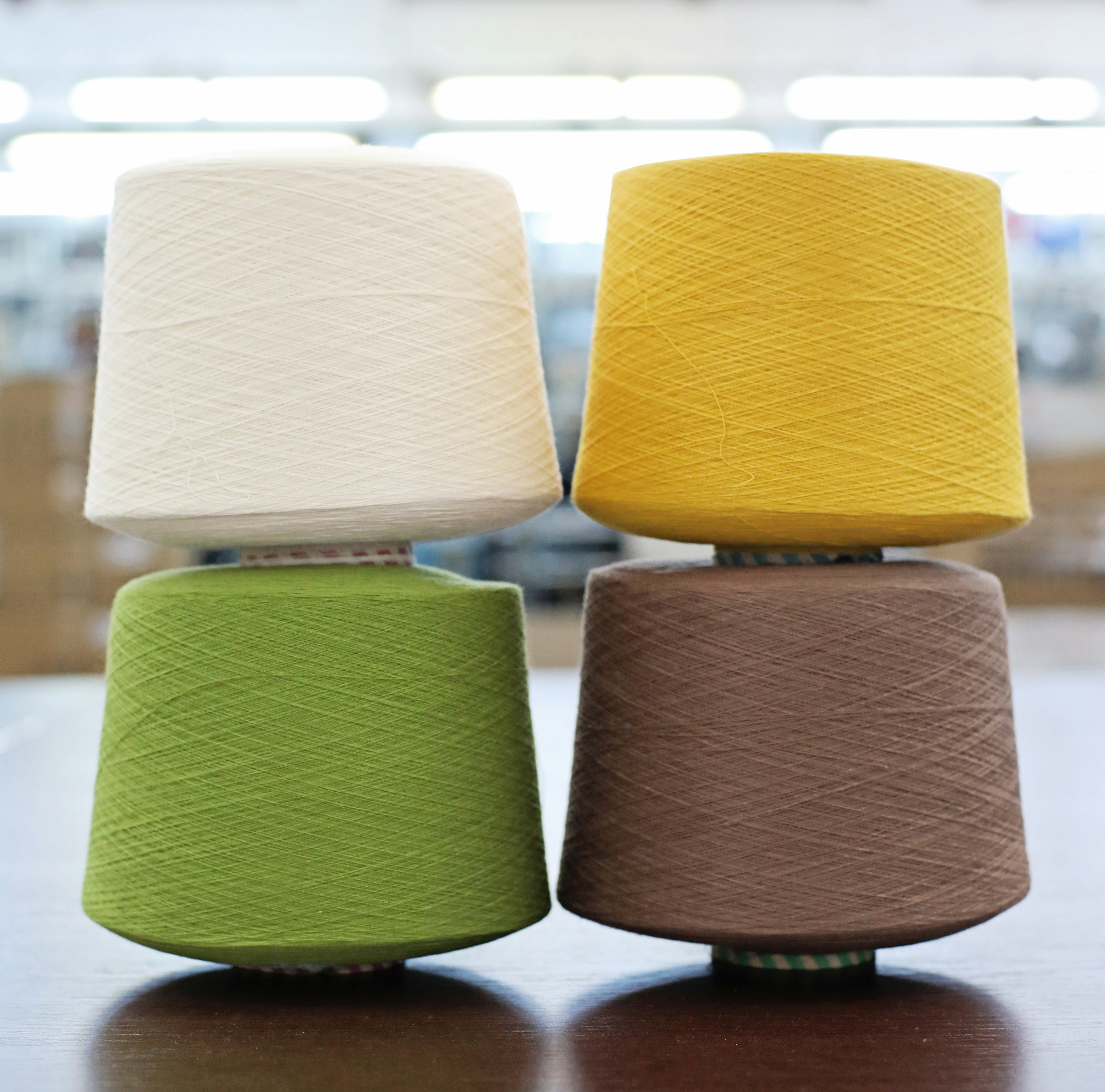 Three different colored yarns sitting on top of a table photo – Free ...