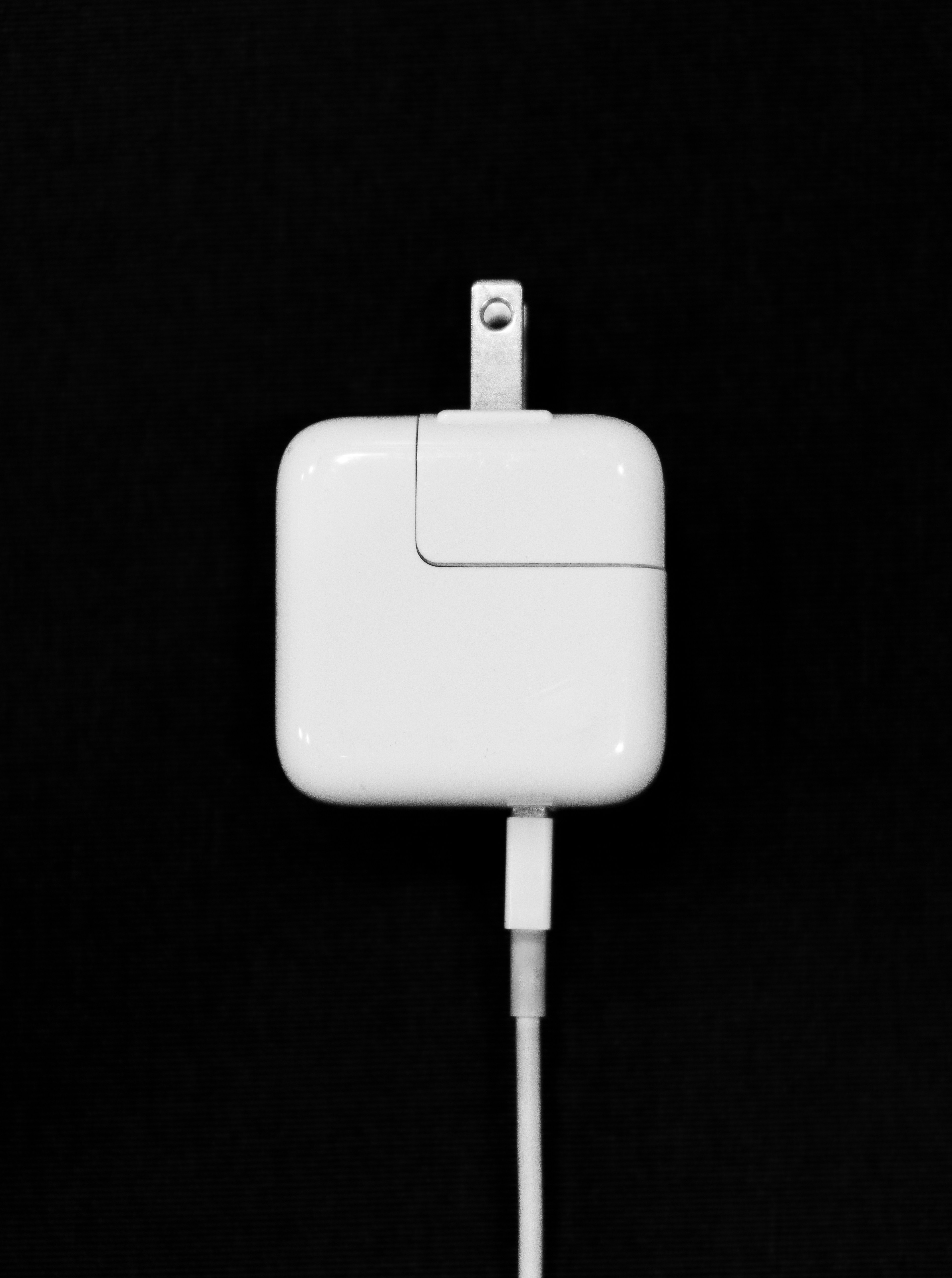 A close up of an apple charger with a black background photo – Free ...