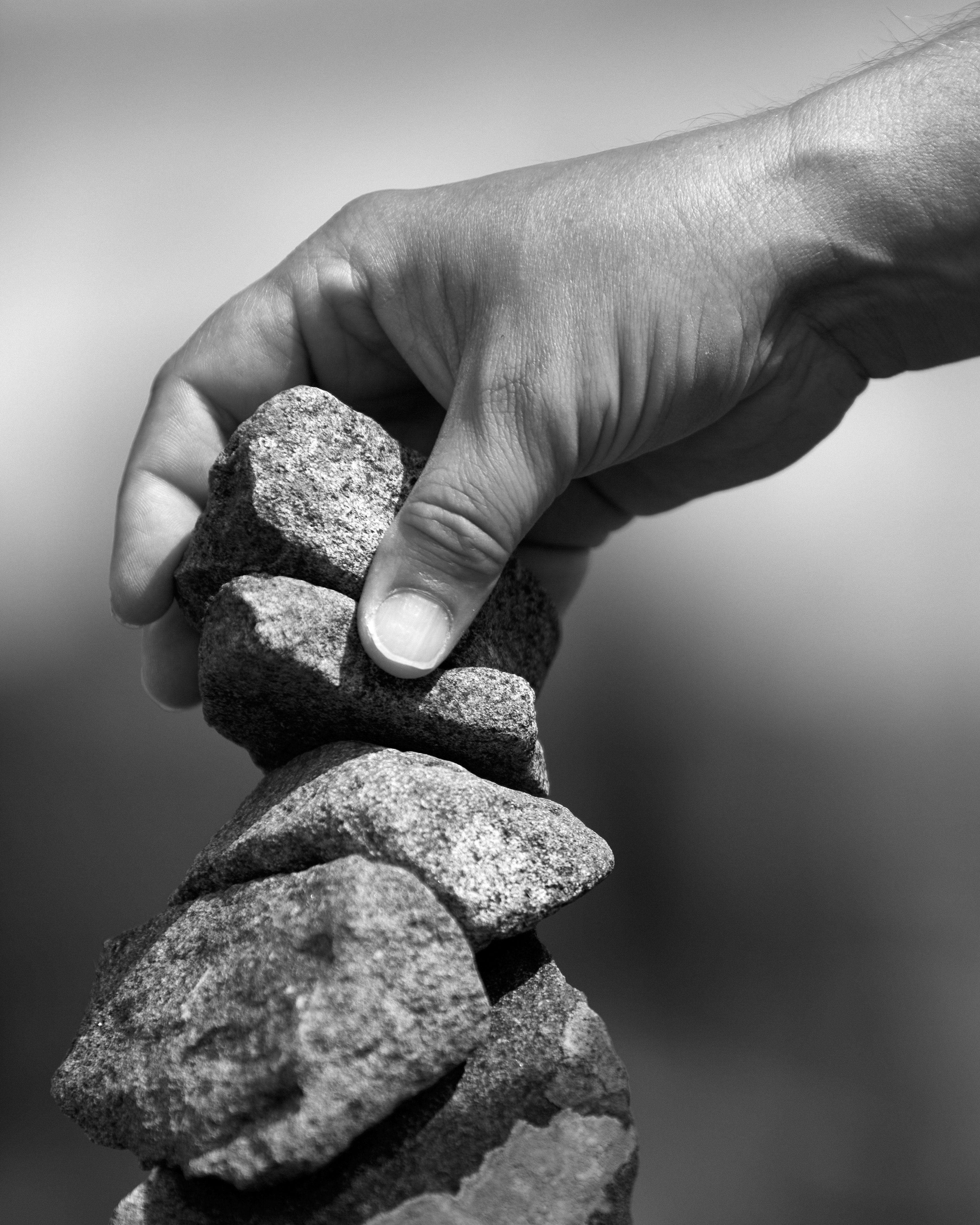 a person stacking rocks on top of each other