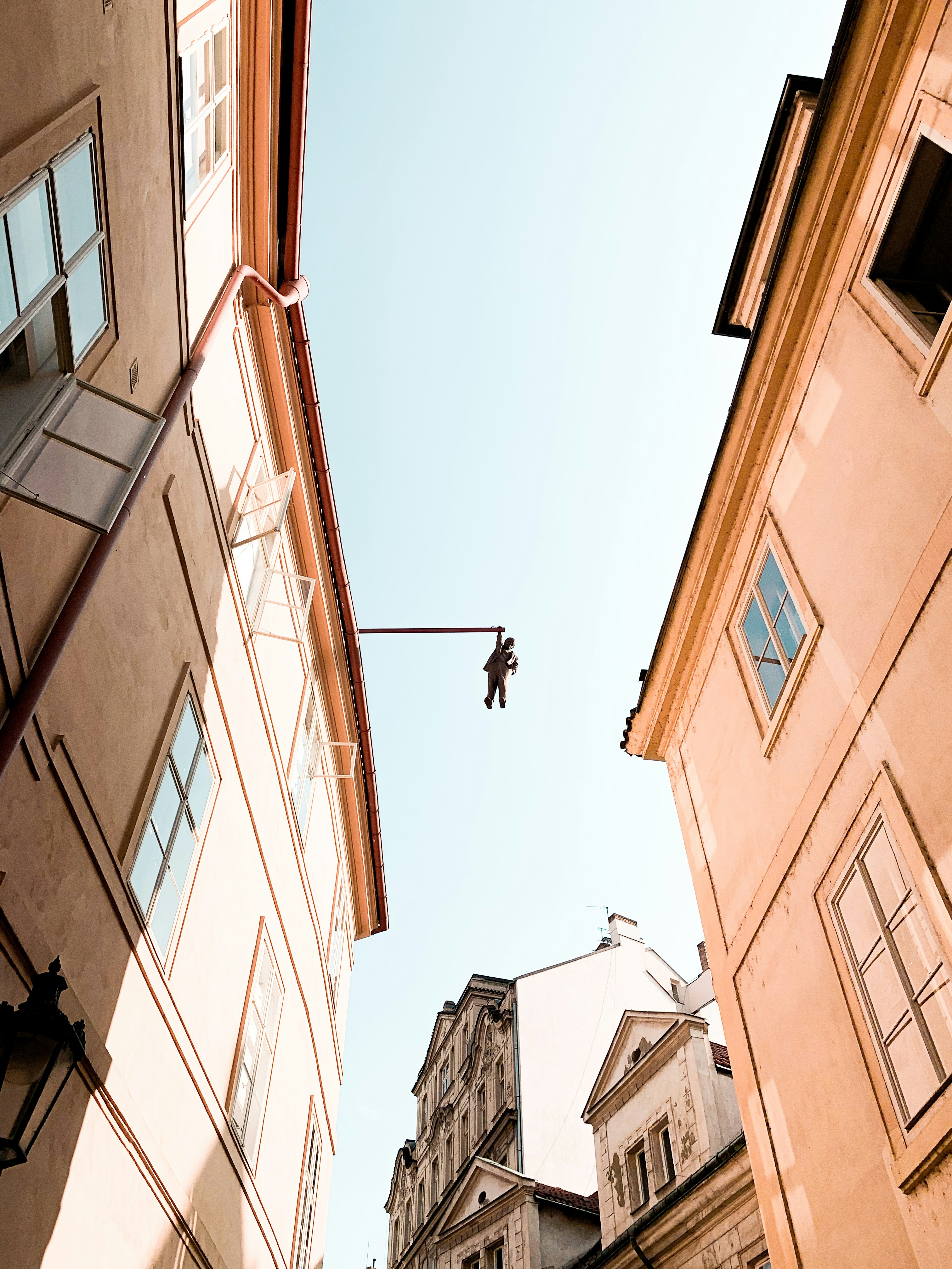 A person on a tightrope between two buildings photo – Free City Image ...