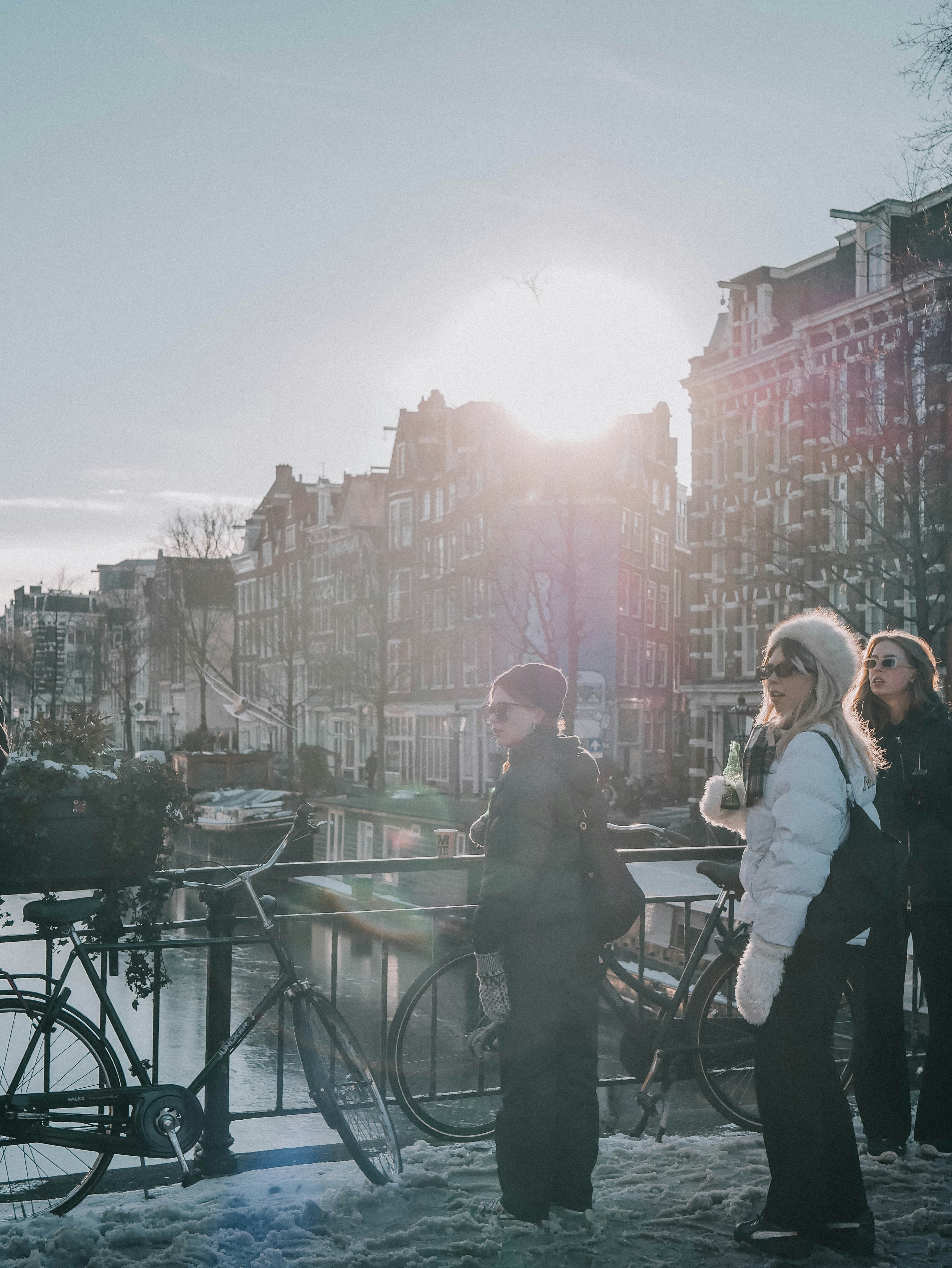 Sunlit Snow by Amsterdam's Canal: Winter Figures in Quiet Light