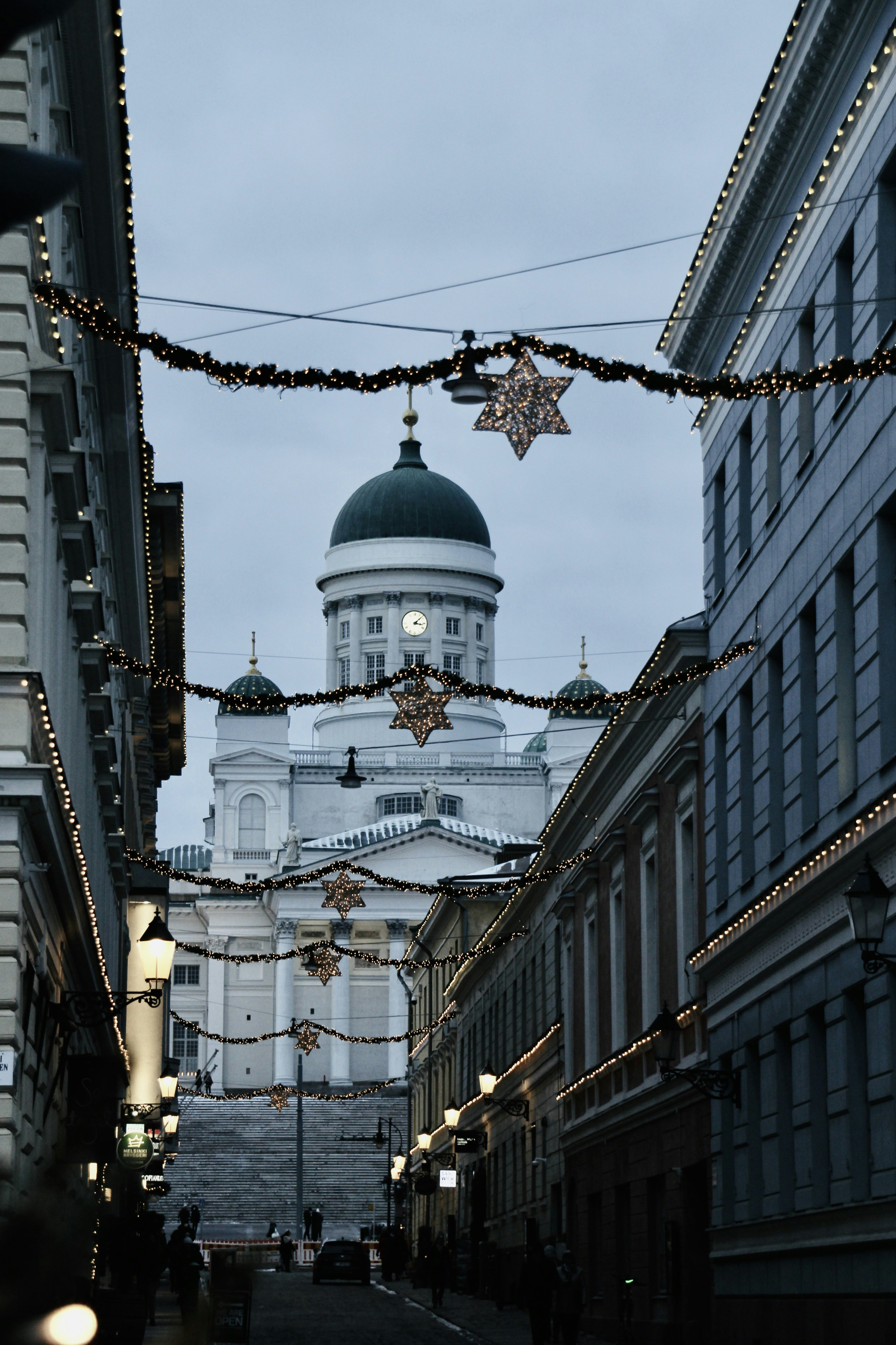 Green-Domed Cathedral Framed by a String-Lit Urban Corridor
