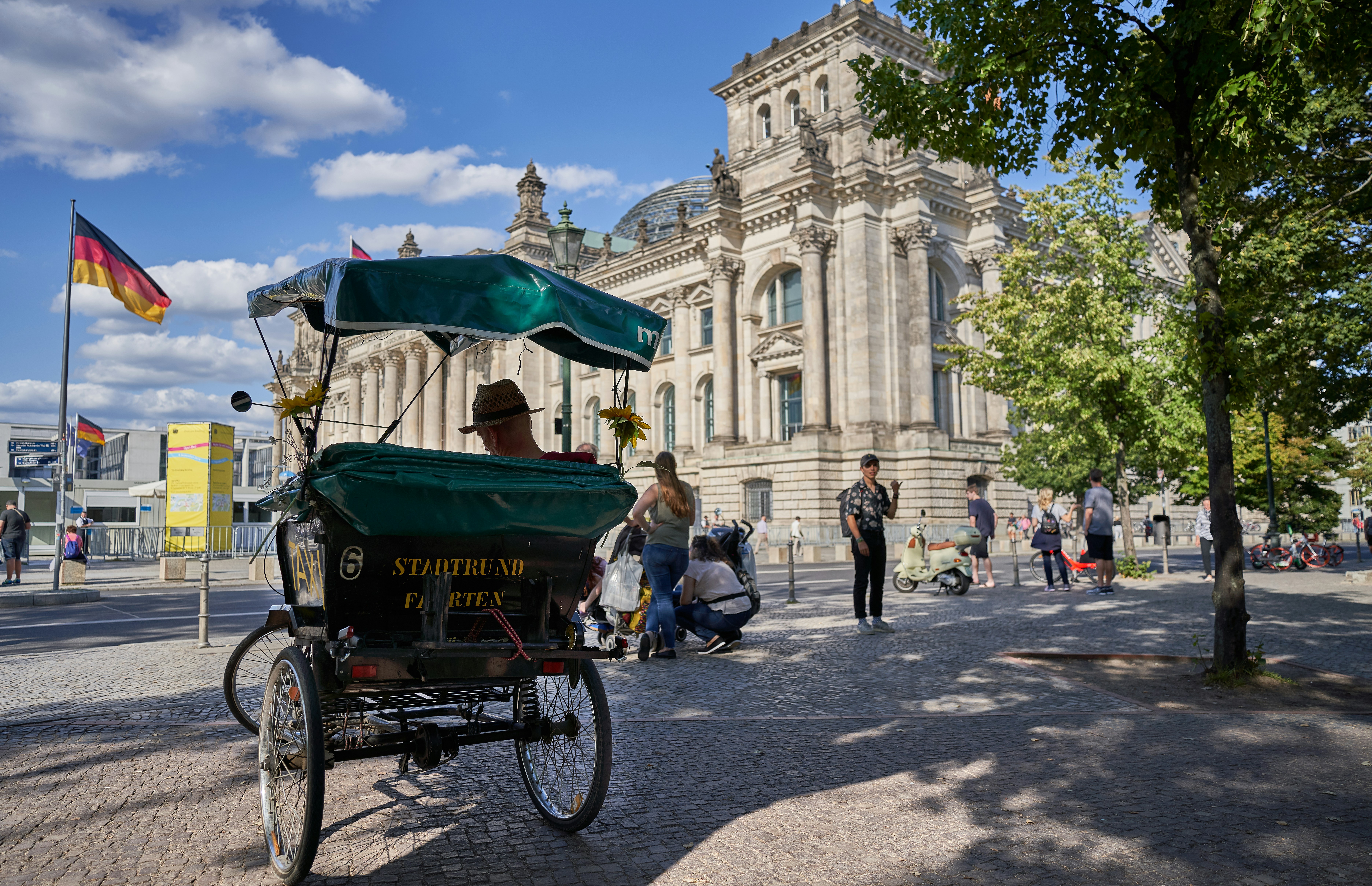 Green-Canopy Pedicab at the Foot of a Baroque Cathedral