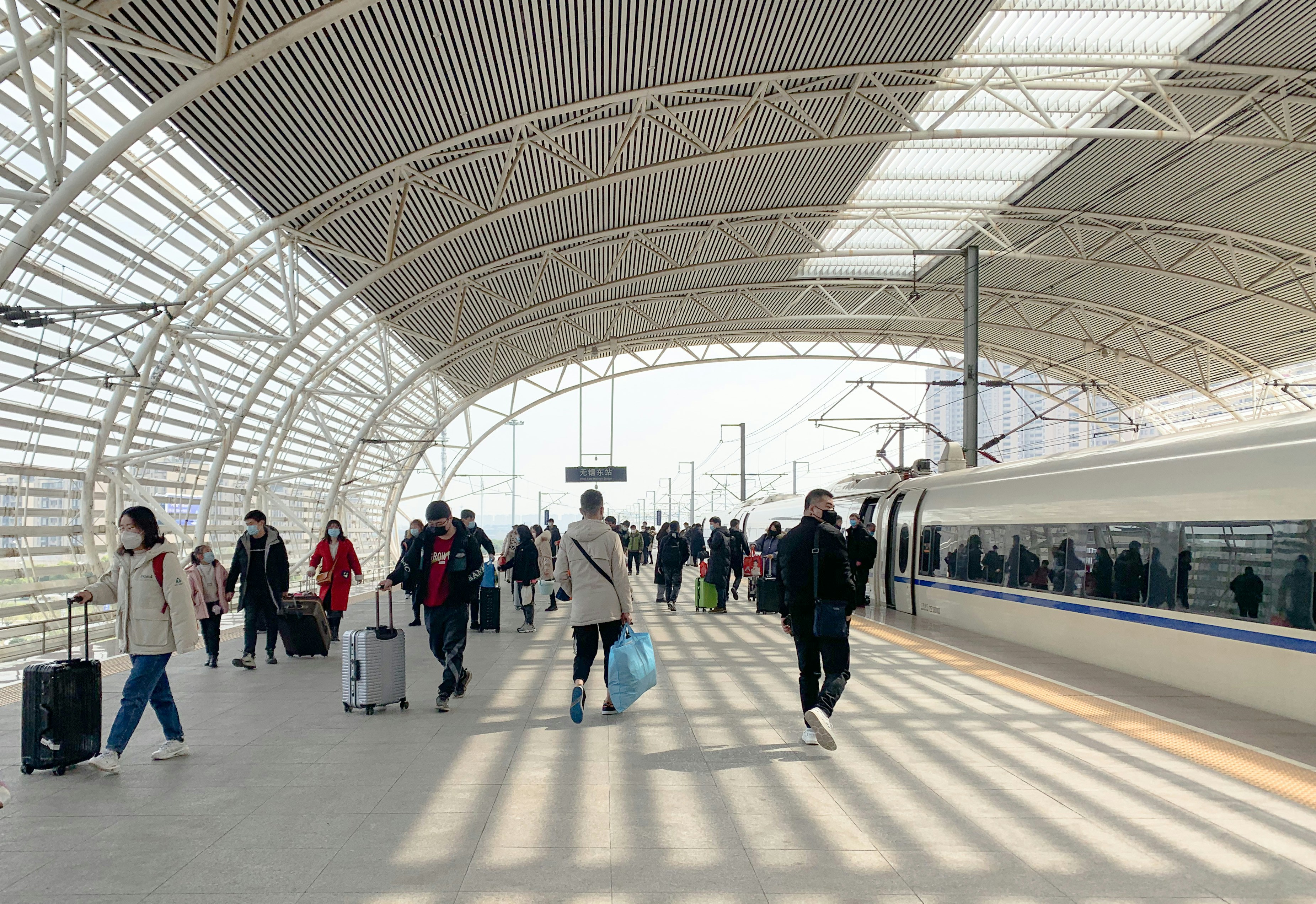 A group of people walking around a train station photo – Free Grey ...