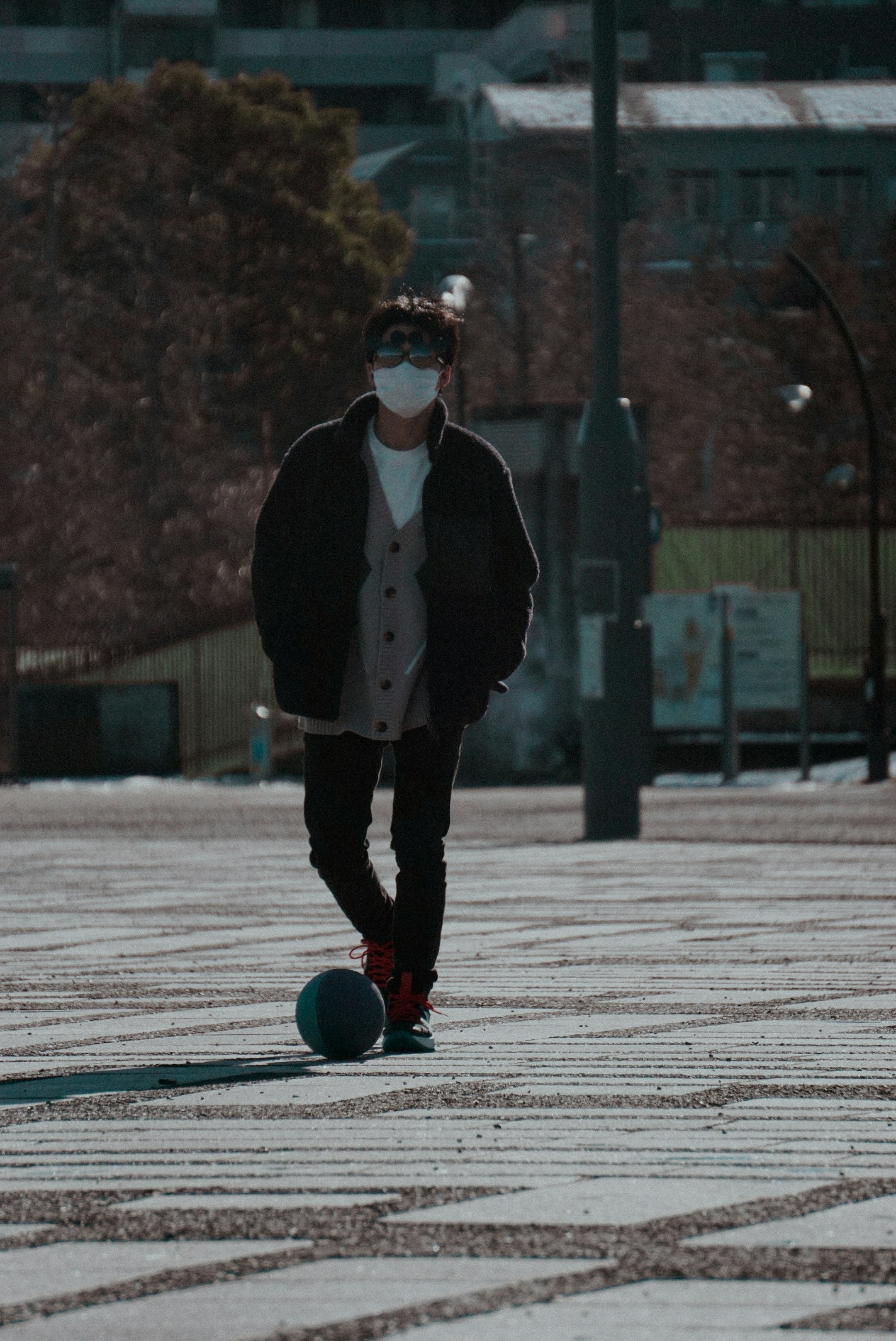Masked Stroll on Checkered Square: A Quiet Urban Moment
