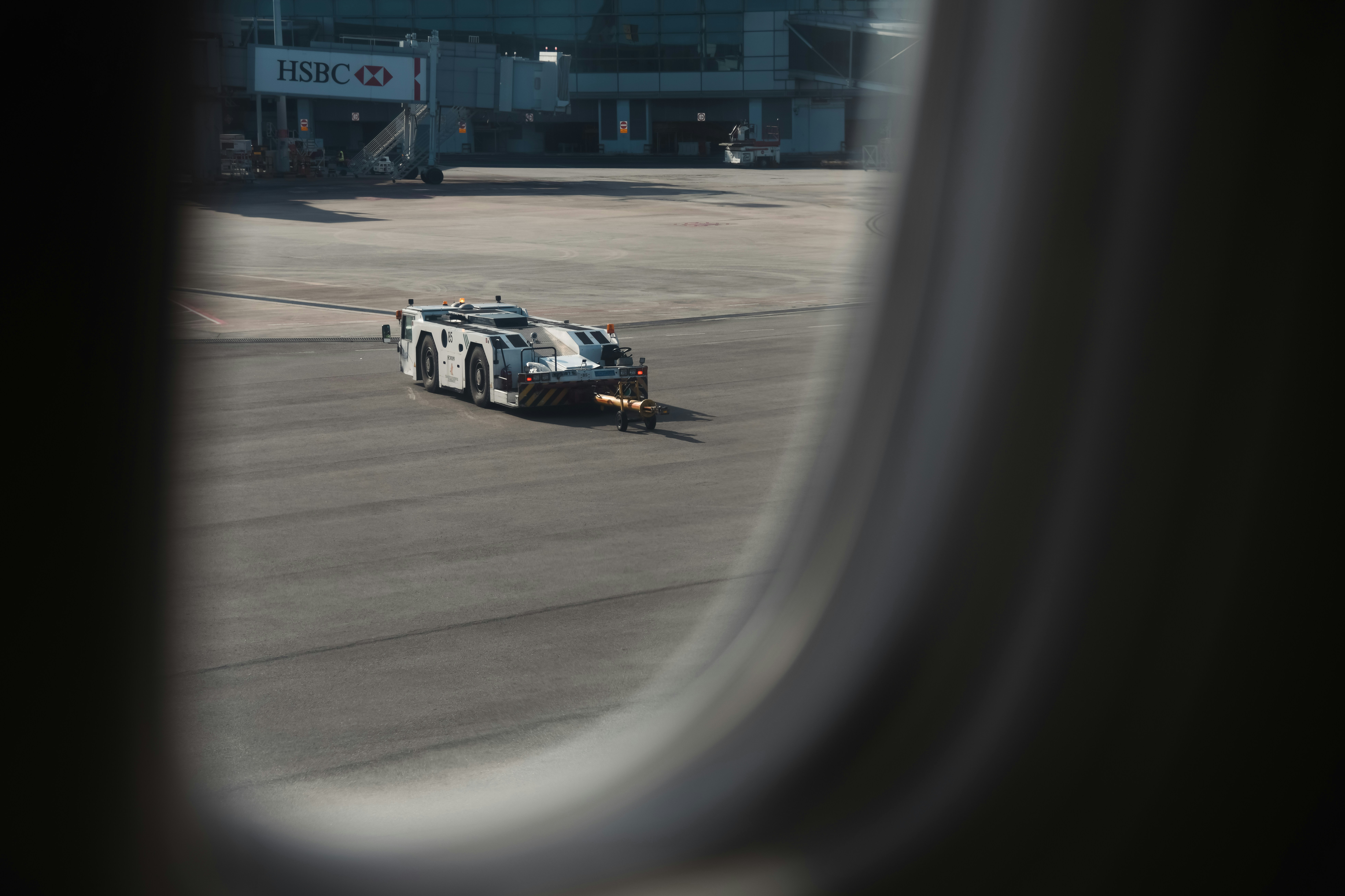 Through the Window to the Apron: A White Race Car on the Airport Tarmac