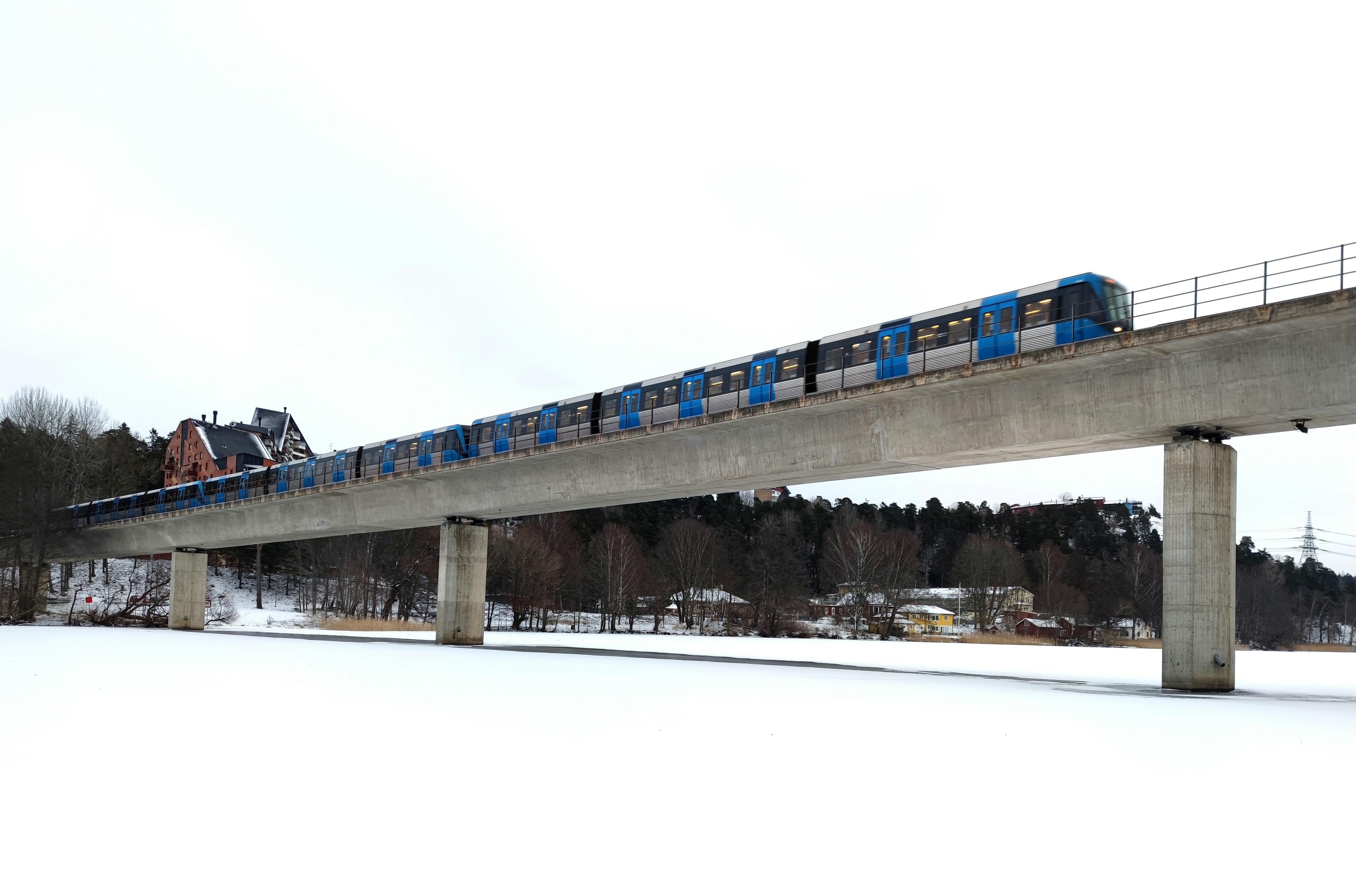 A train traveling over a bridge in the snow photo – Free Train Image on ...