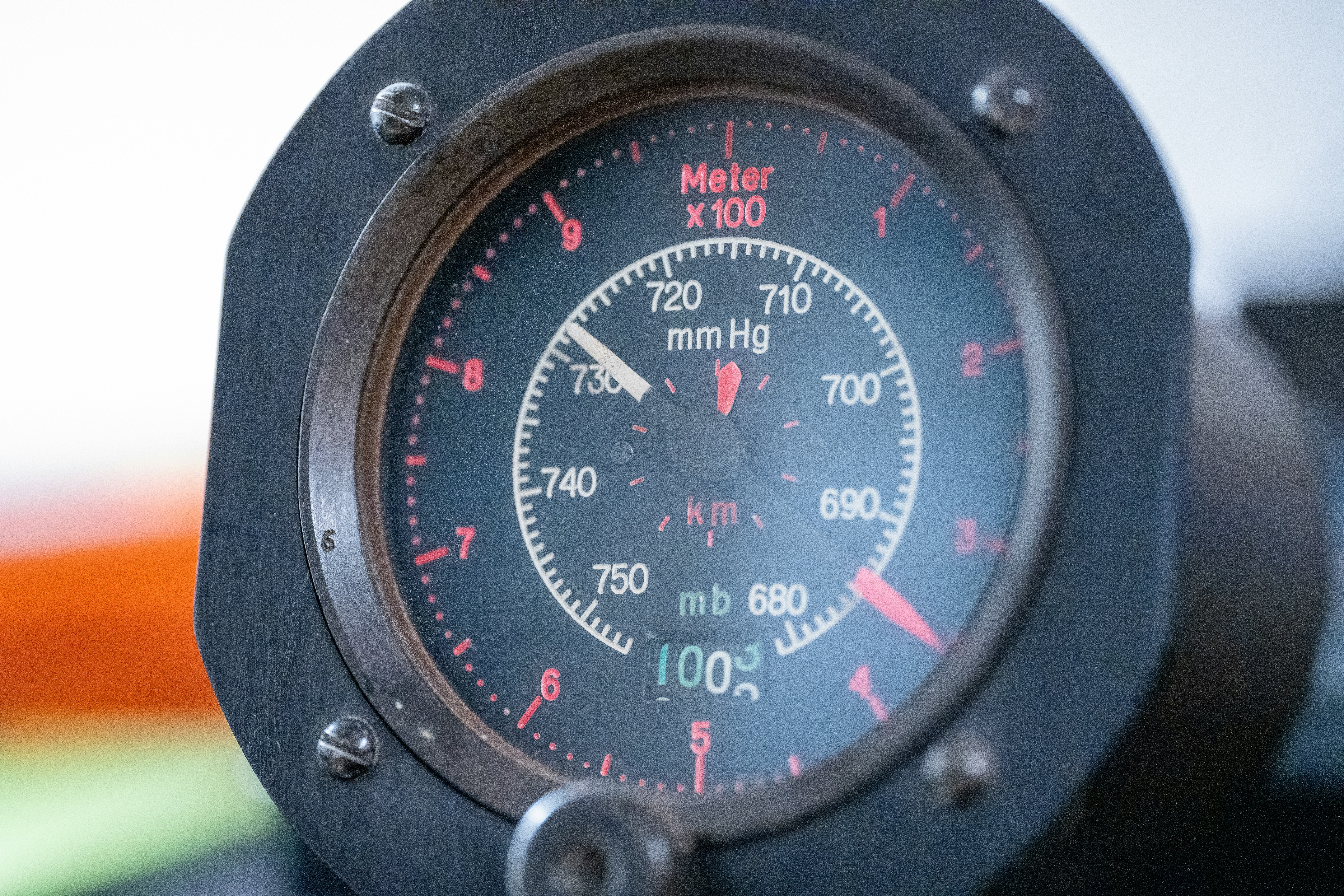 Close-up of a pressure gauge displaying readings in mmHg, with a focus on the intricate dial and markings.