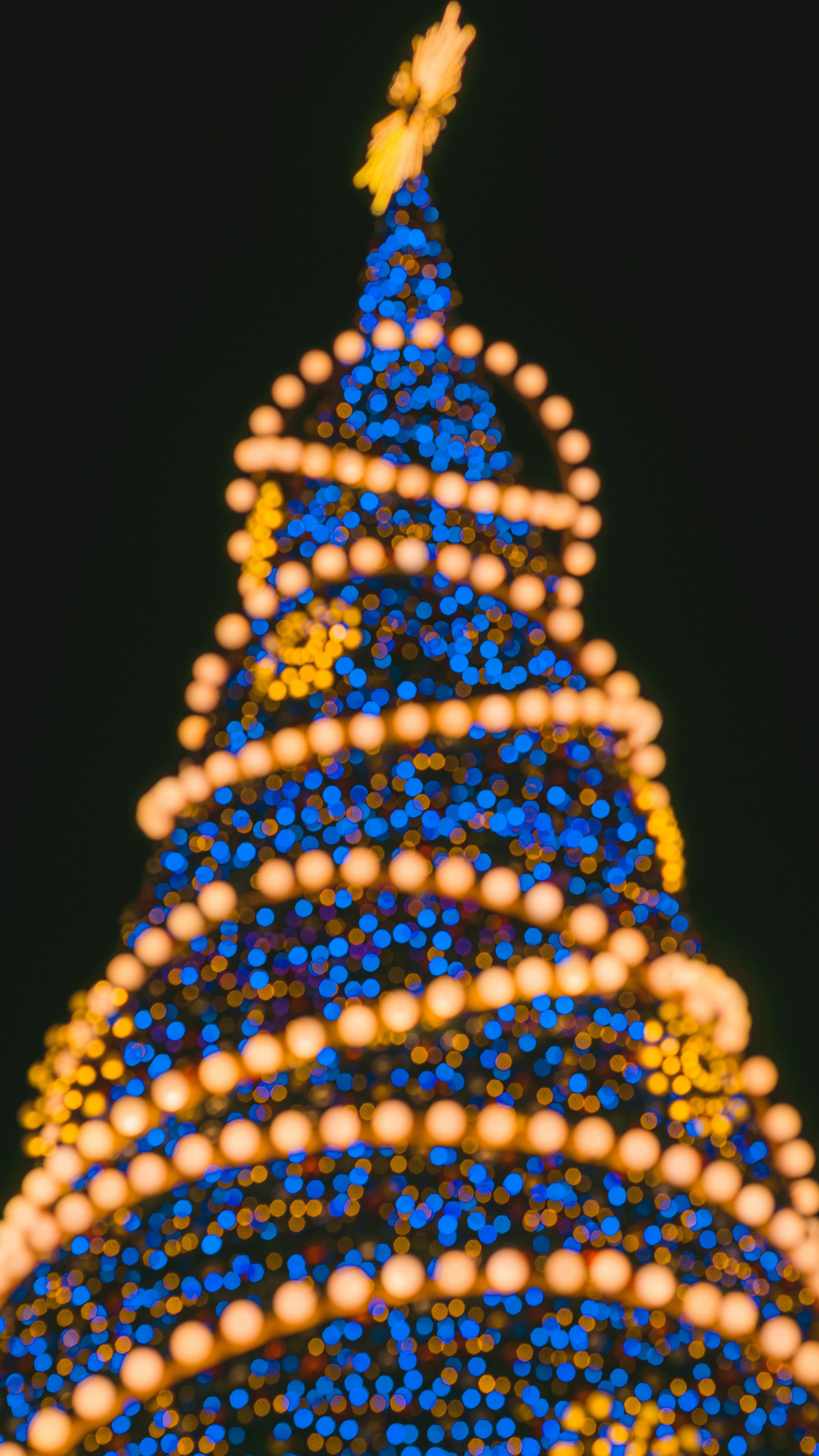 Twilight Spiral: Blue and Amber Lights Coil into a Dreamy Christmas Tree