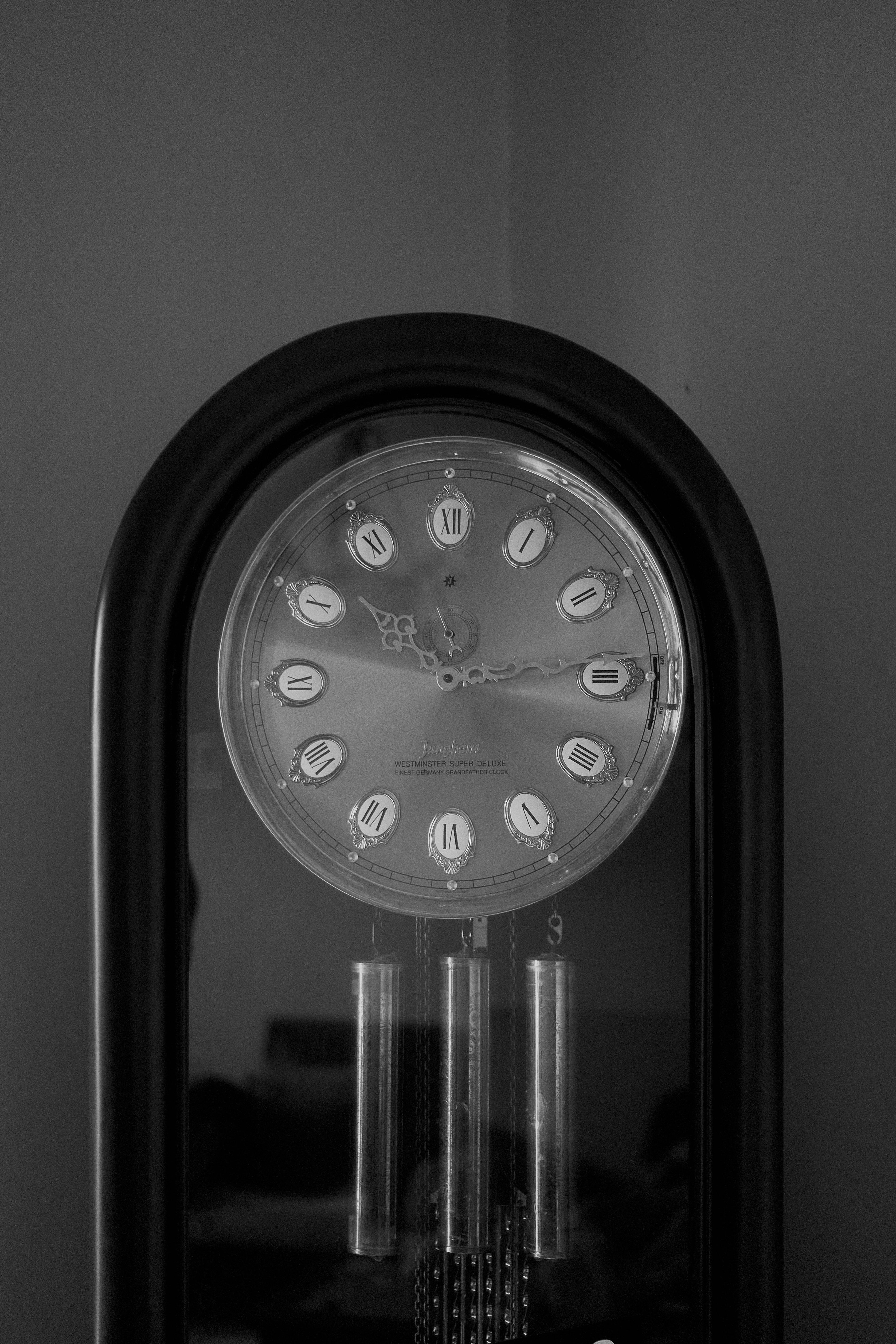 a black and white photo of a clock on a wall
