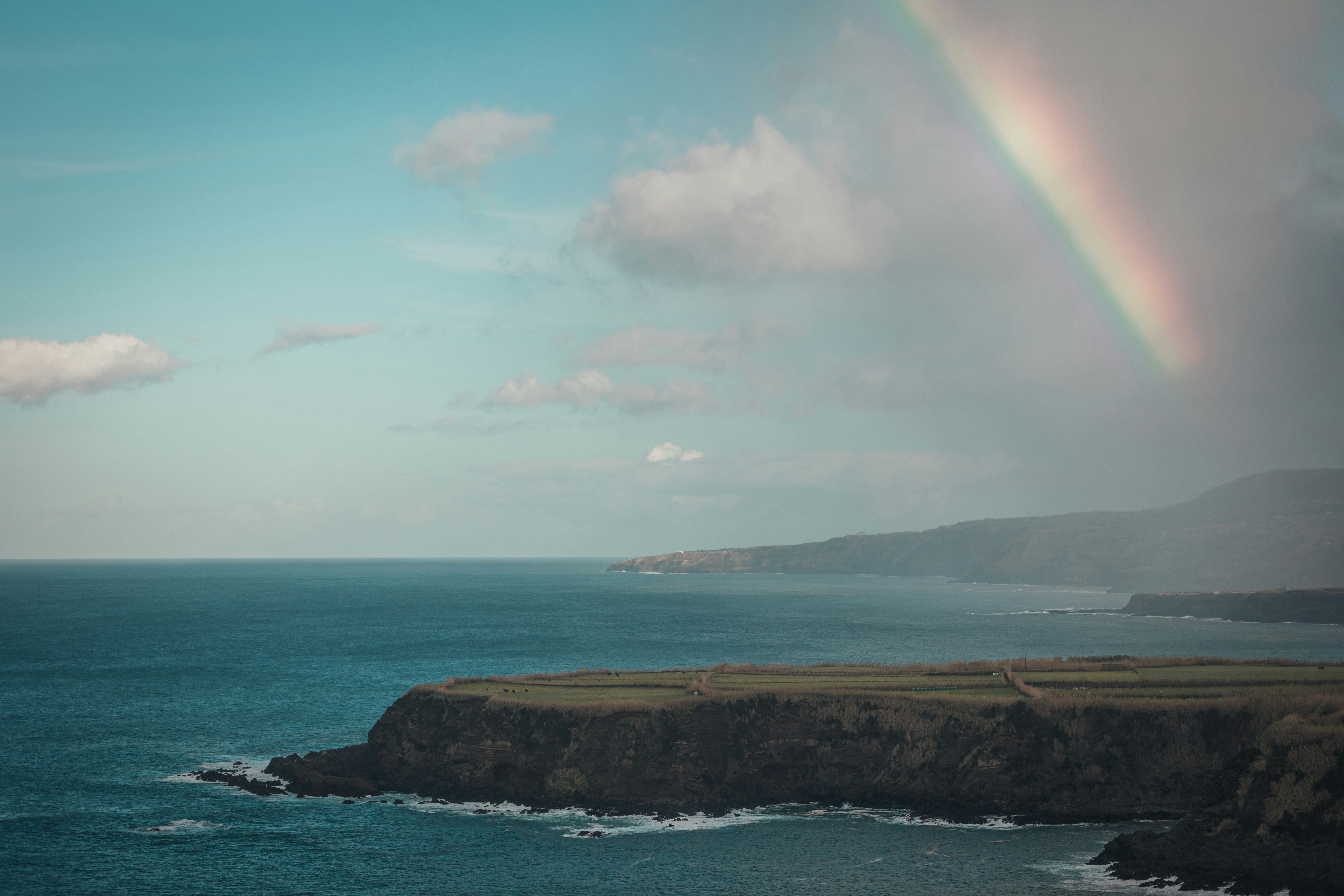 Rainbow Arc over Windswept Headland along the Atlantic Coast