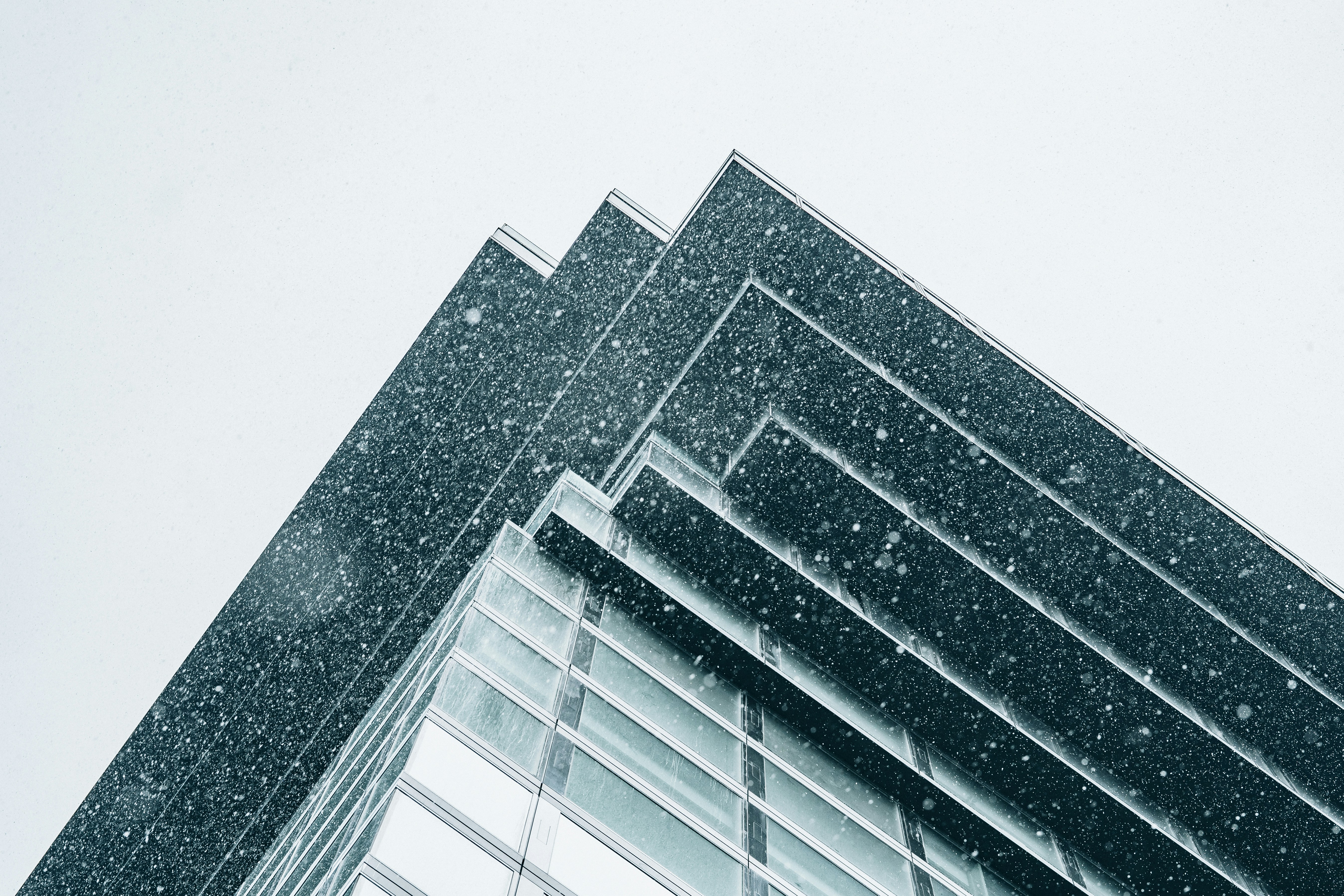 Industrial Geometry: Snowy Edge of Glass and Concrete