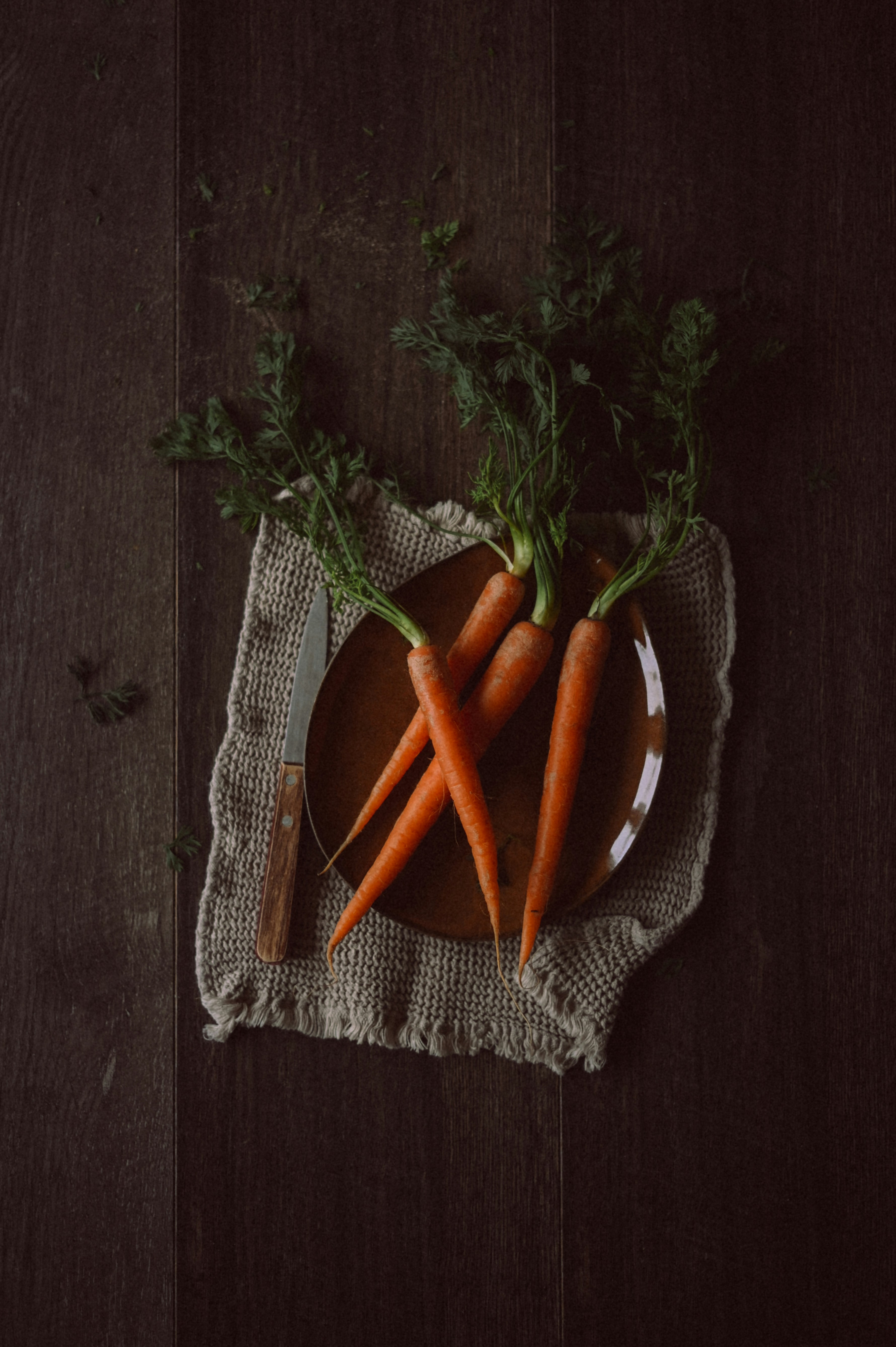 Napkin-Soft Harvest: Carrots on a Dark Table
