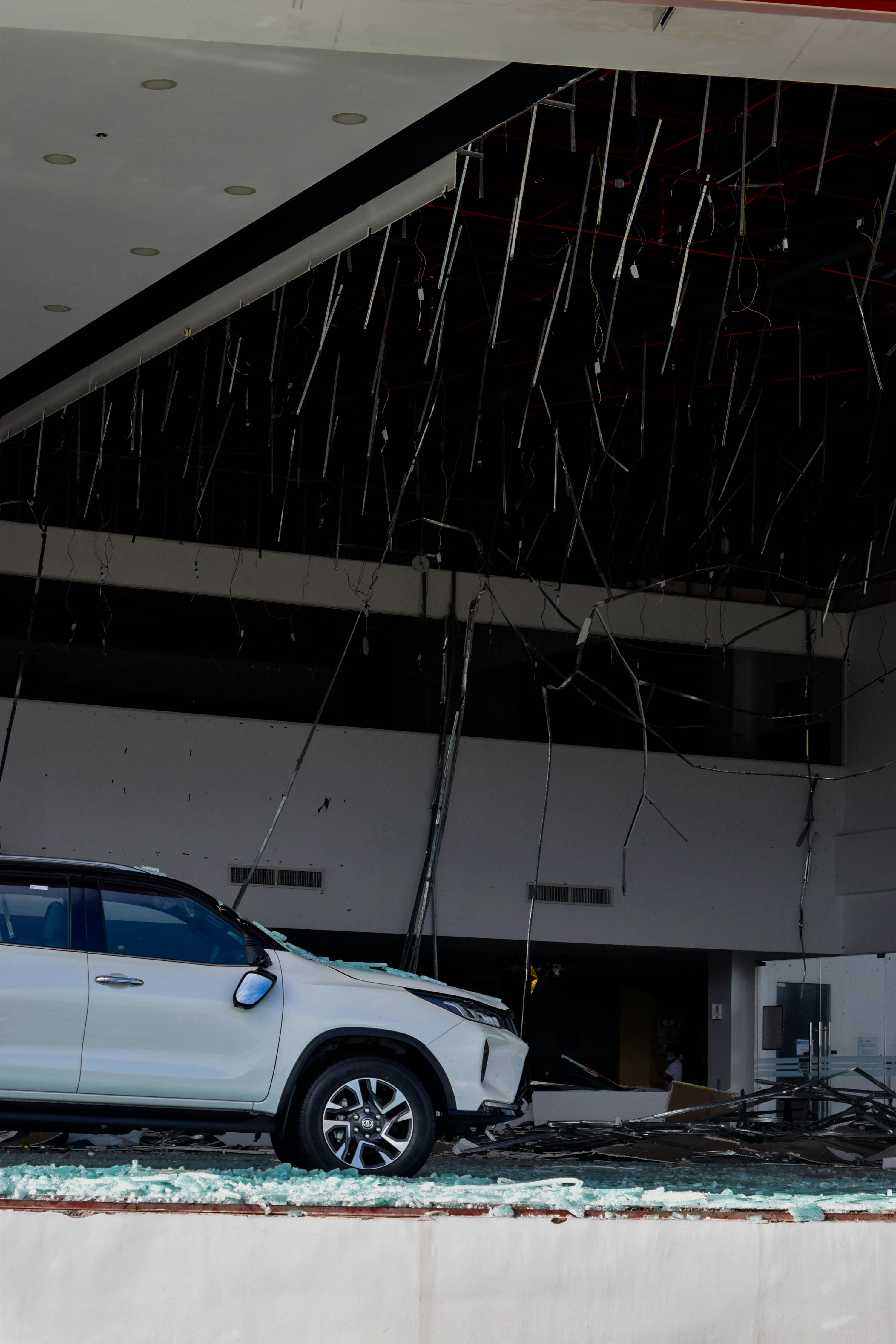 White SUV at the Edge of a Damaged Interior