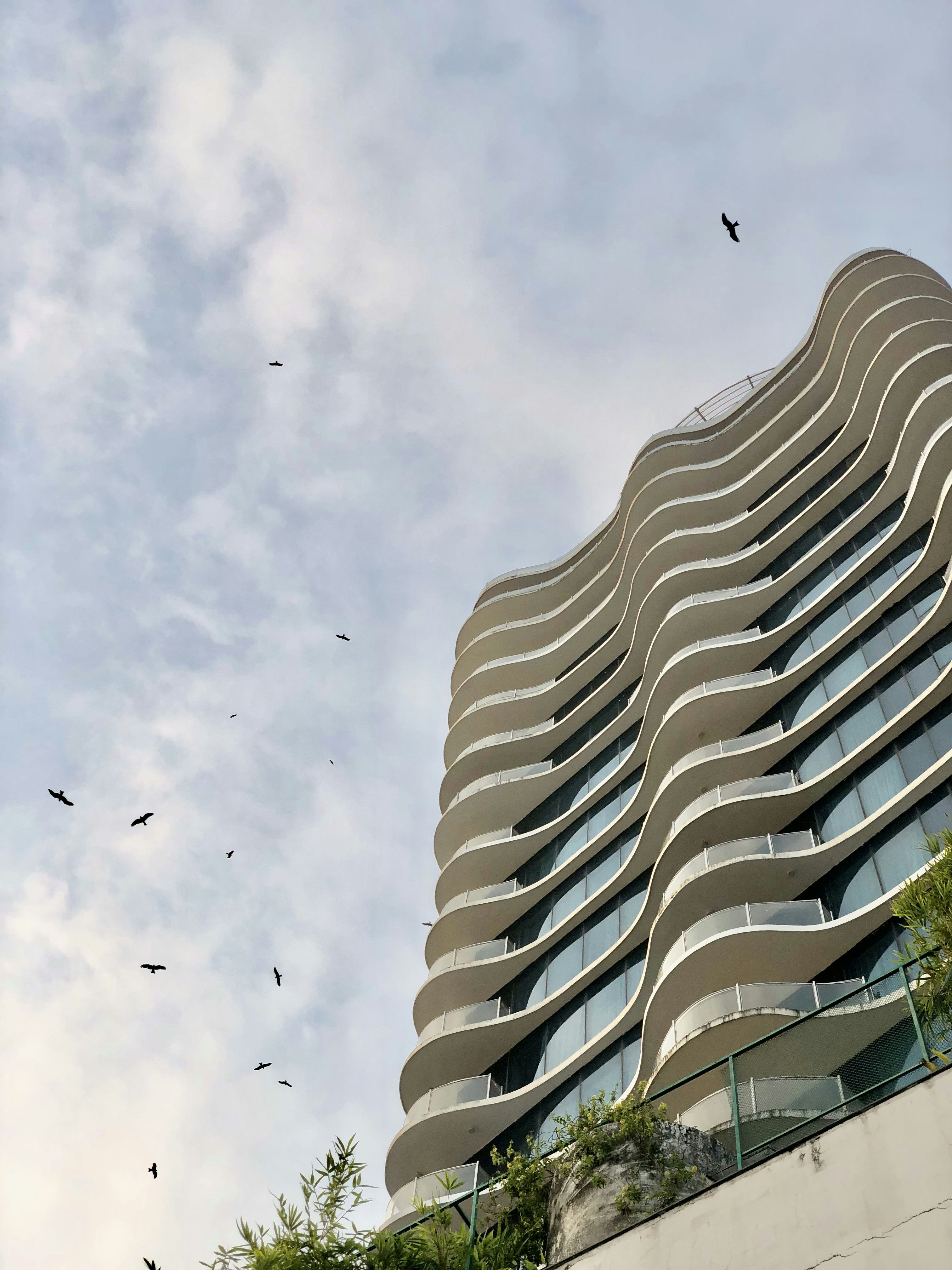 Curved Facade in Motion: Waves of Balcony Architecture Against a Sky