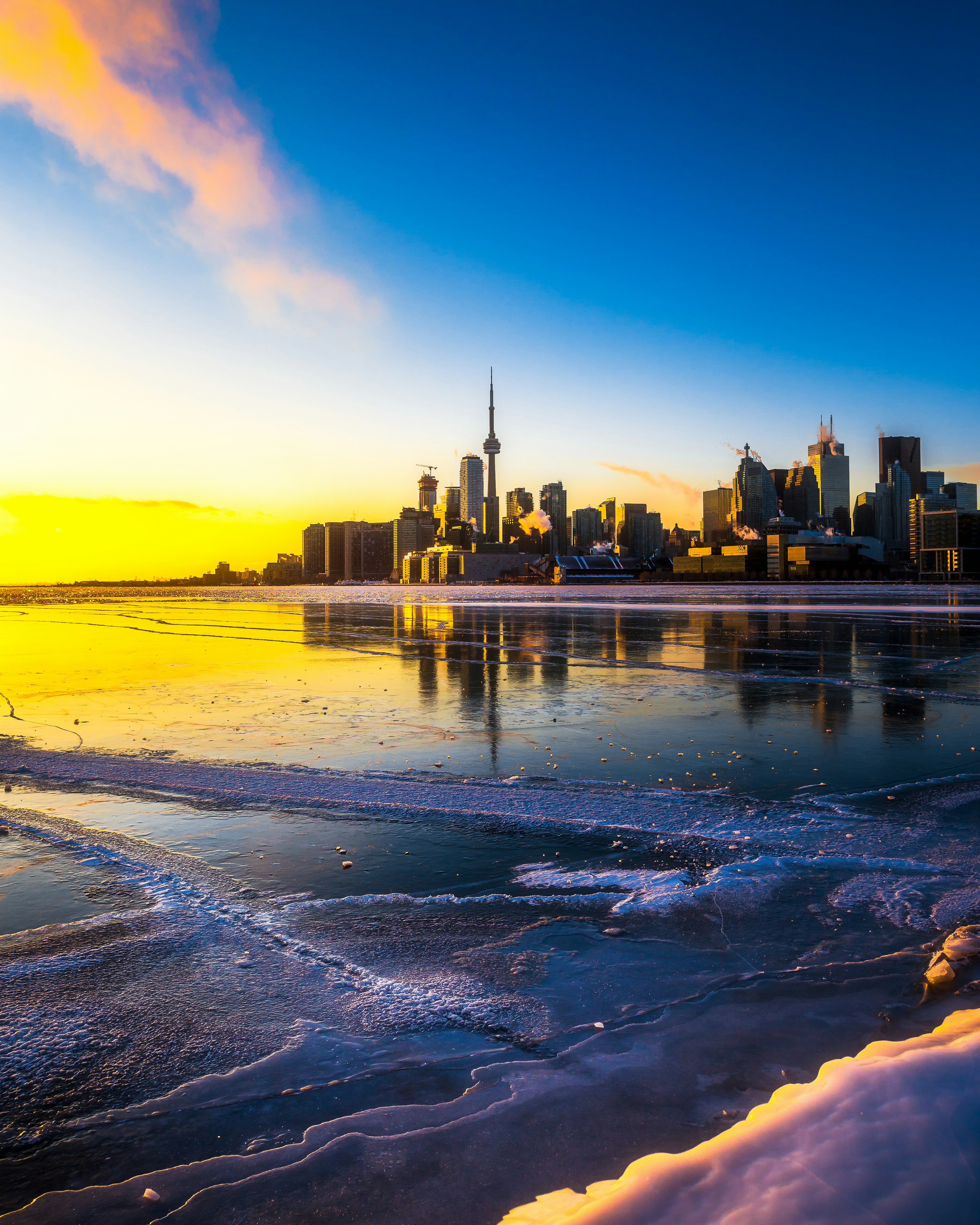 Sunlit Skyline Over Frozen harbor at Dawn