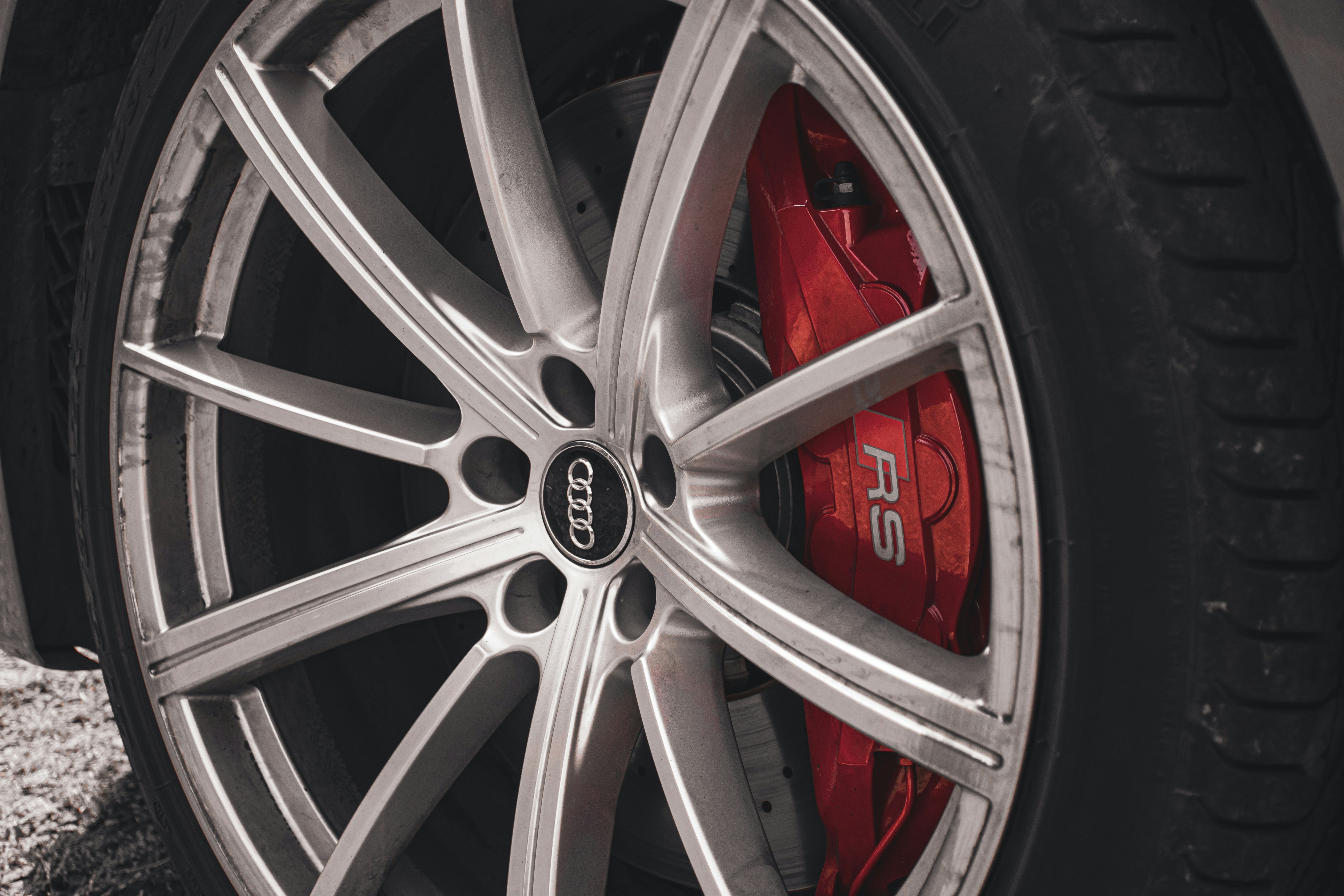 Red Brilliance: Audi RS brake caliper framed by alloy spokes