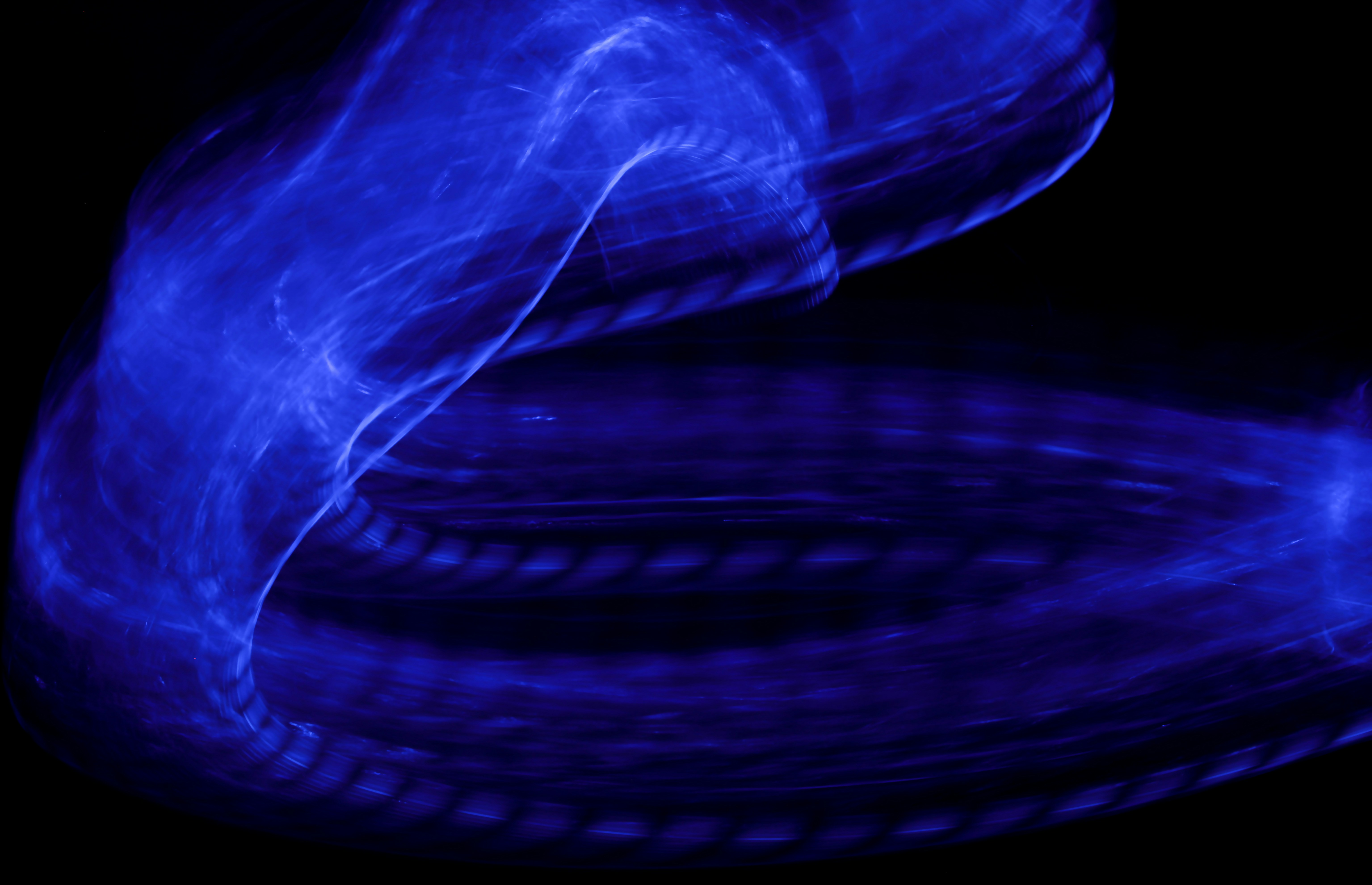 Blue Light Serpent: A Long-Exposure Ribbon Dancing in Darkness