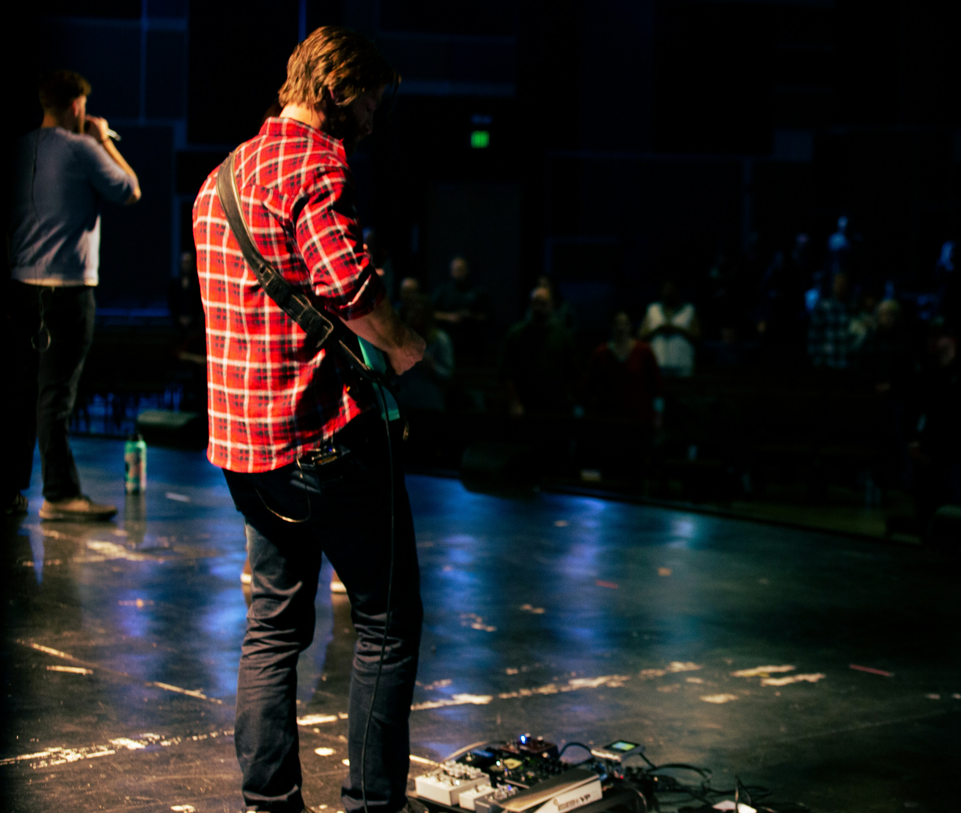 a man standing on a stage holding a microphone