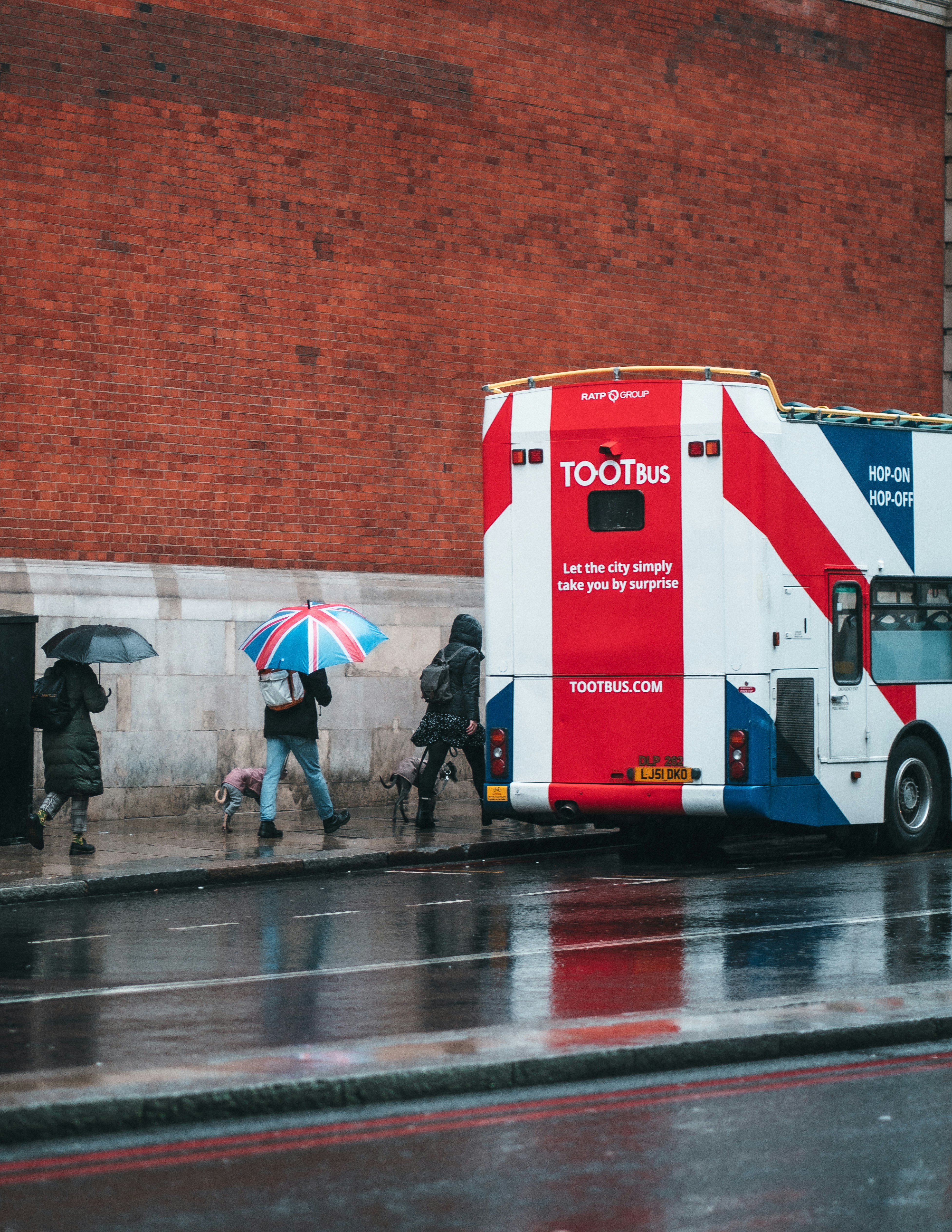 Umbrella Parade by the Rain-Soaked Street