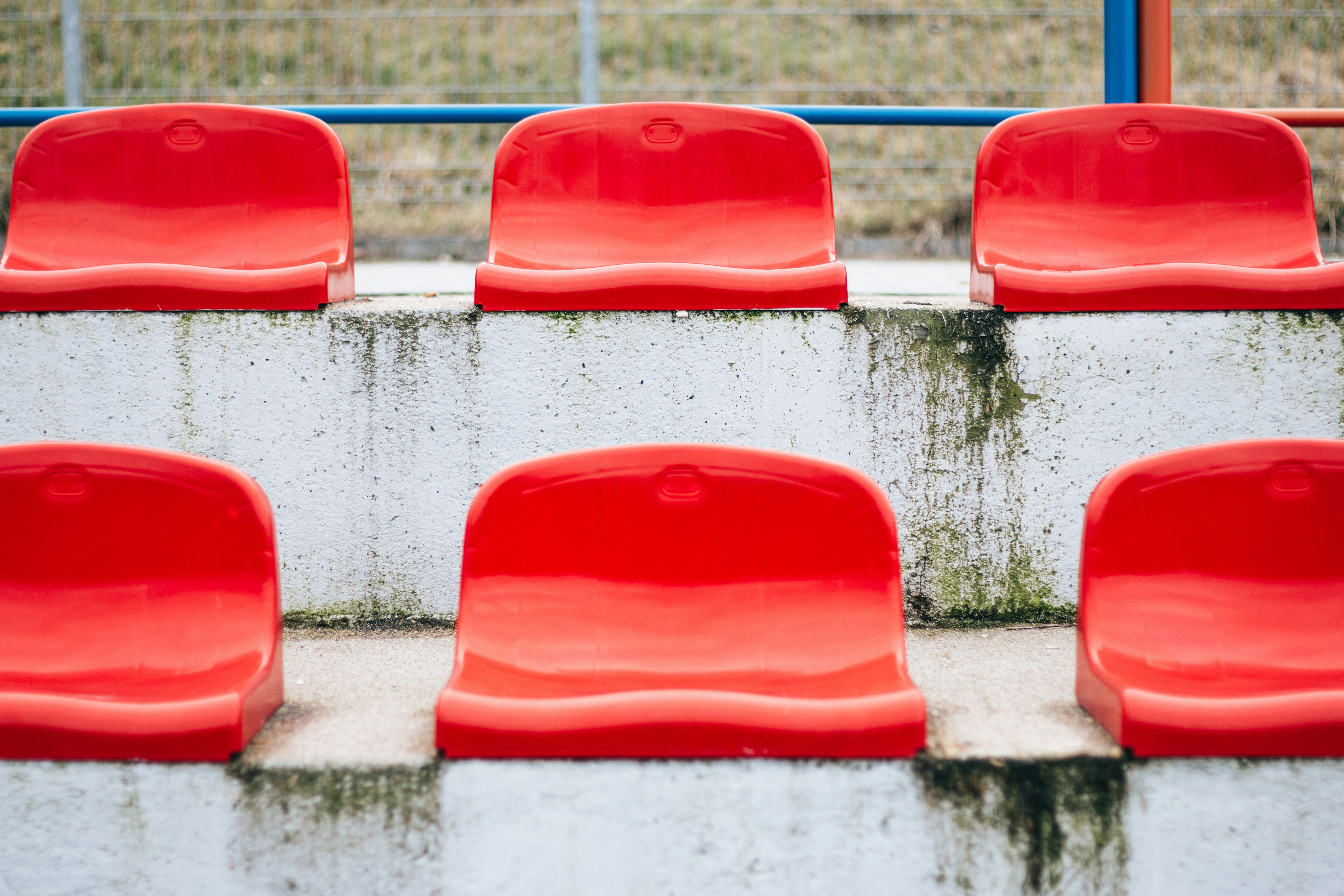 Red Stadium Seats in Quiet Concrete Taction