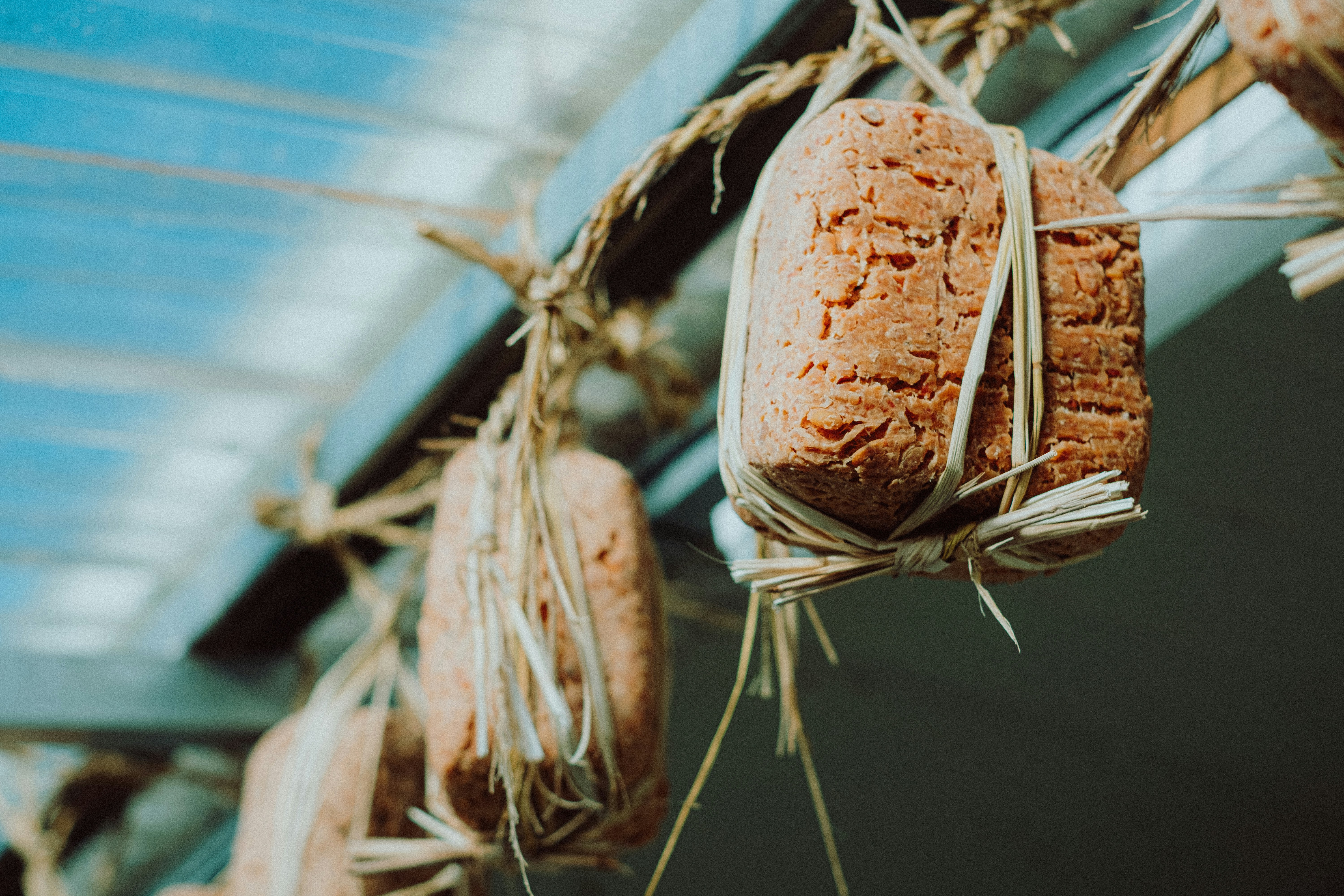 A bunch of bread hanging from a ceiling photo – Free Fermented soybean ...