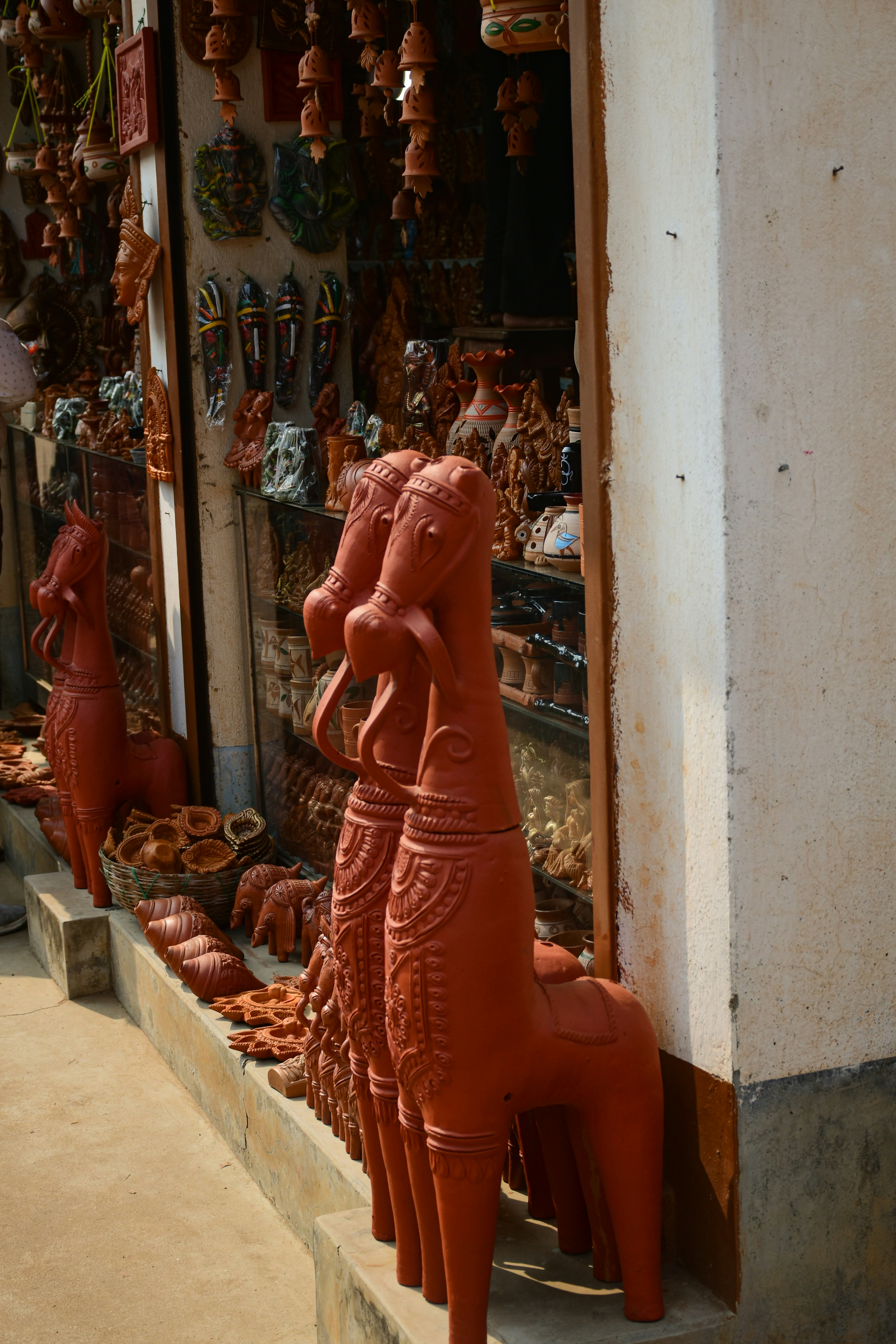 a red statue of a dog in front of a store