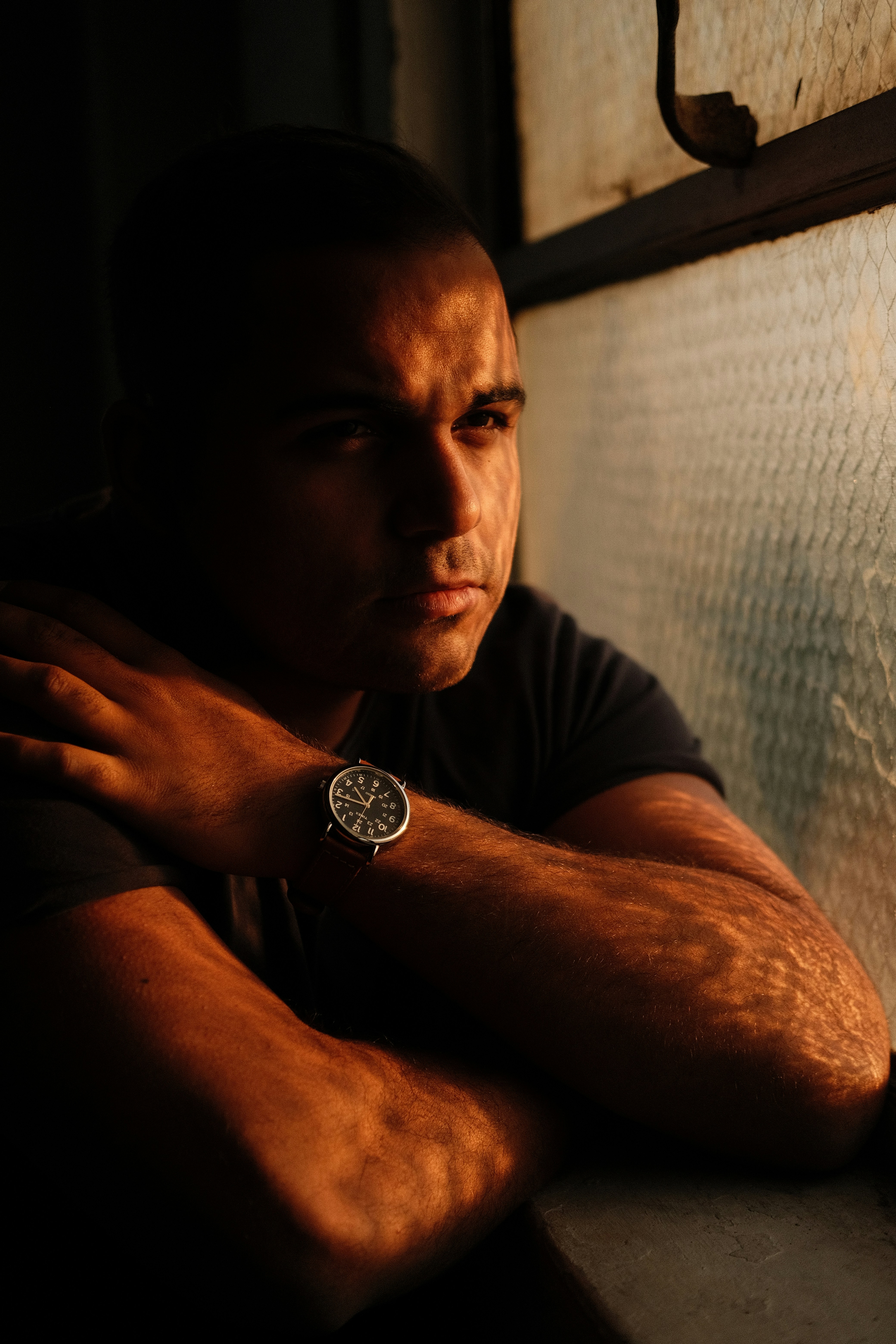 A man leaning on a window sill with his arms crossed photo – Free ...