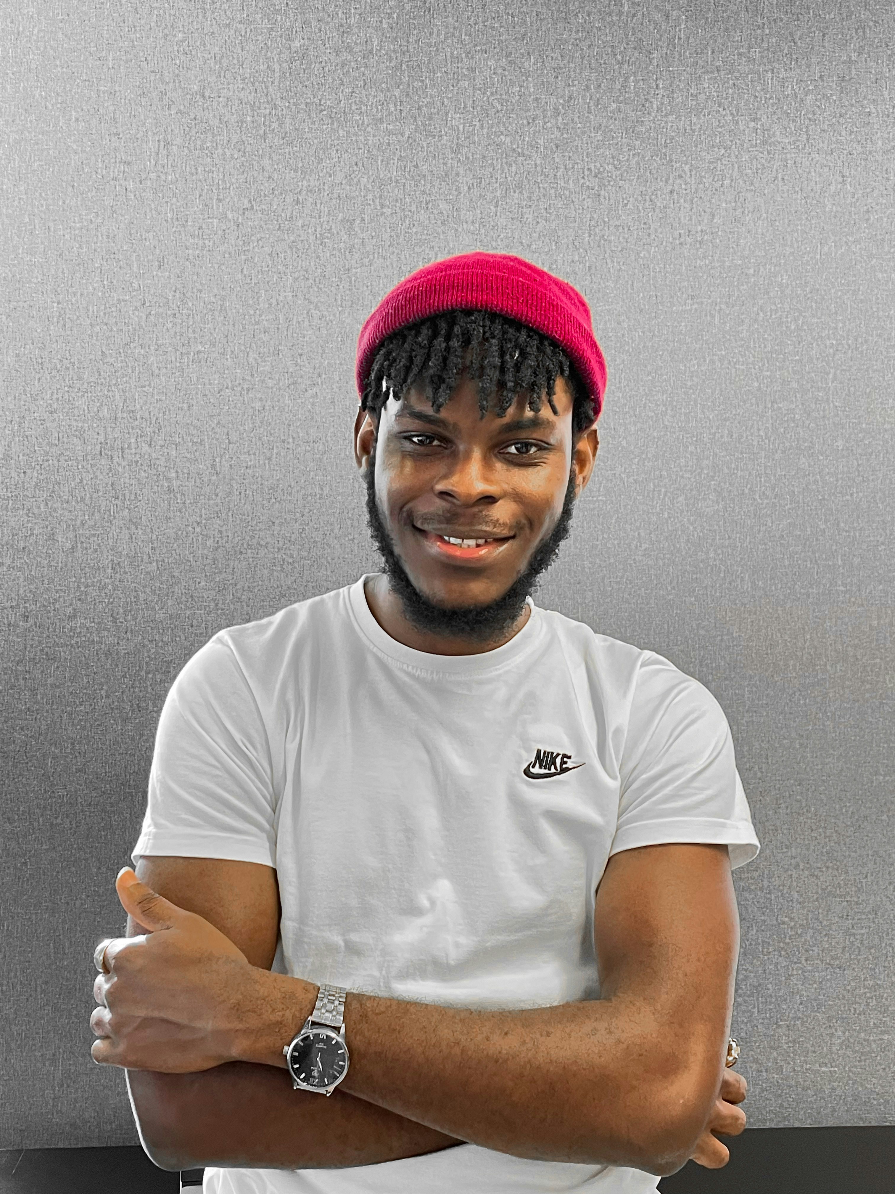 Red Beanie Confidence: Studio Portrait of a Nike Tee Wearer