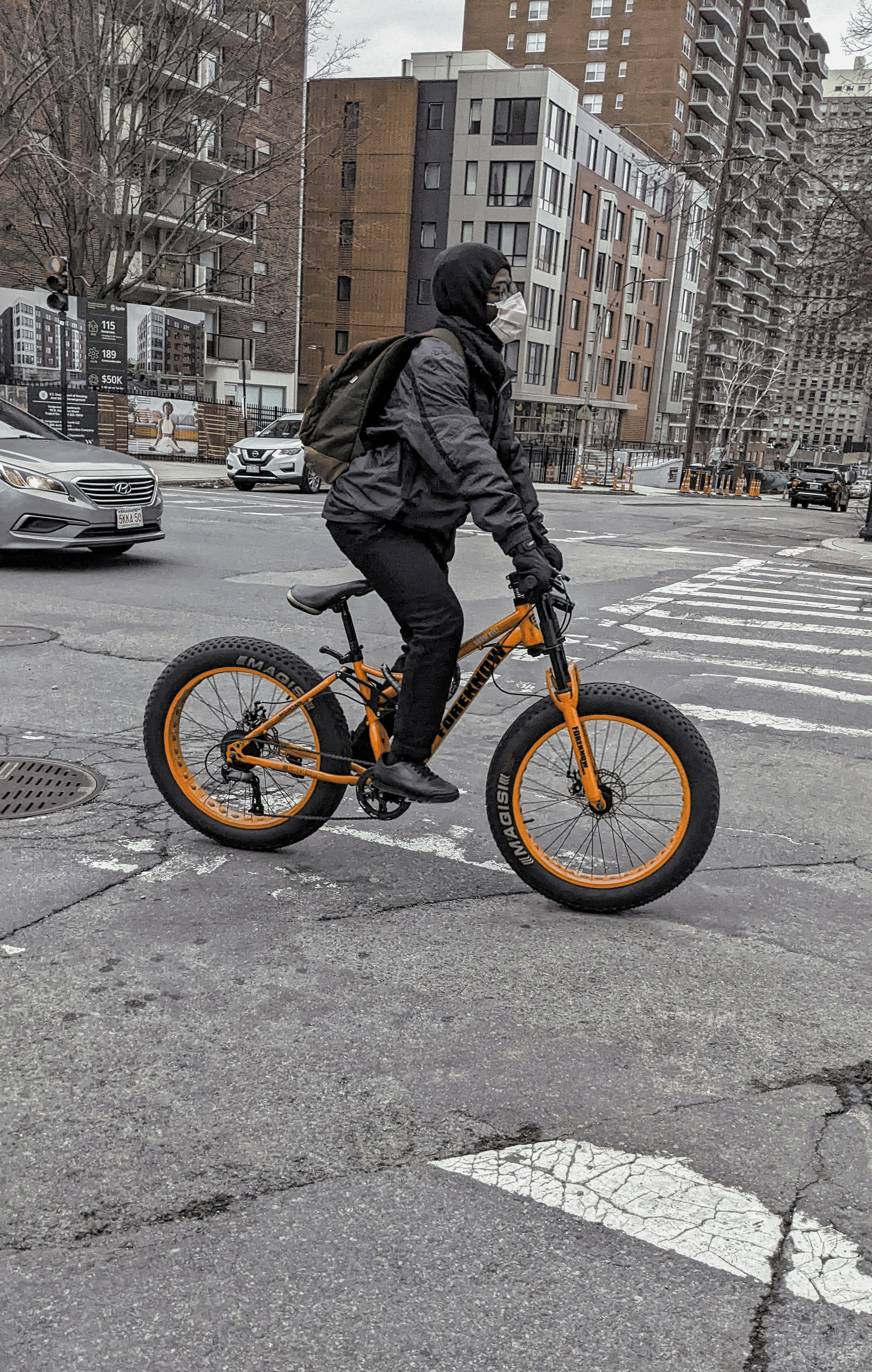 a person riding a bike on a city street