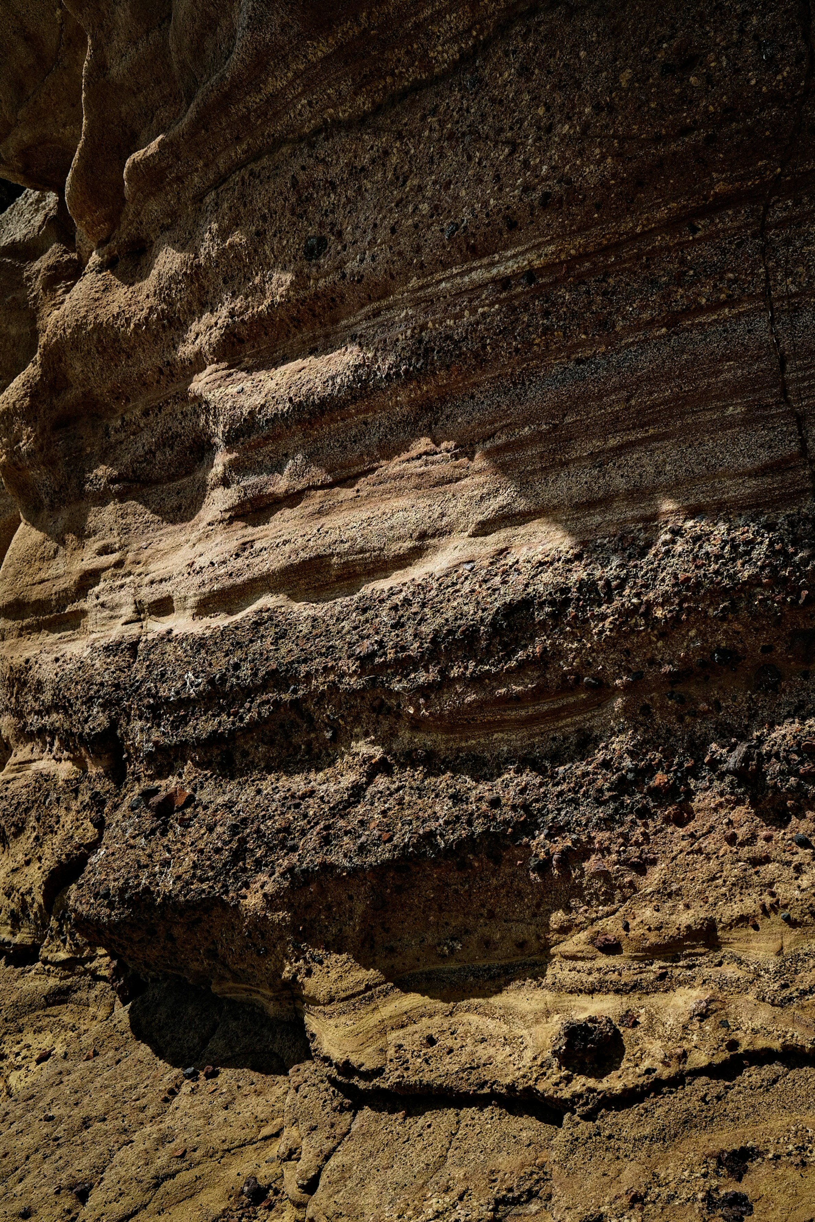Textured rock formations displaying intricate layers and patterns created by natural erosion processes.