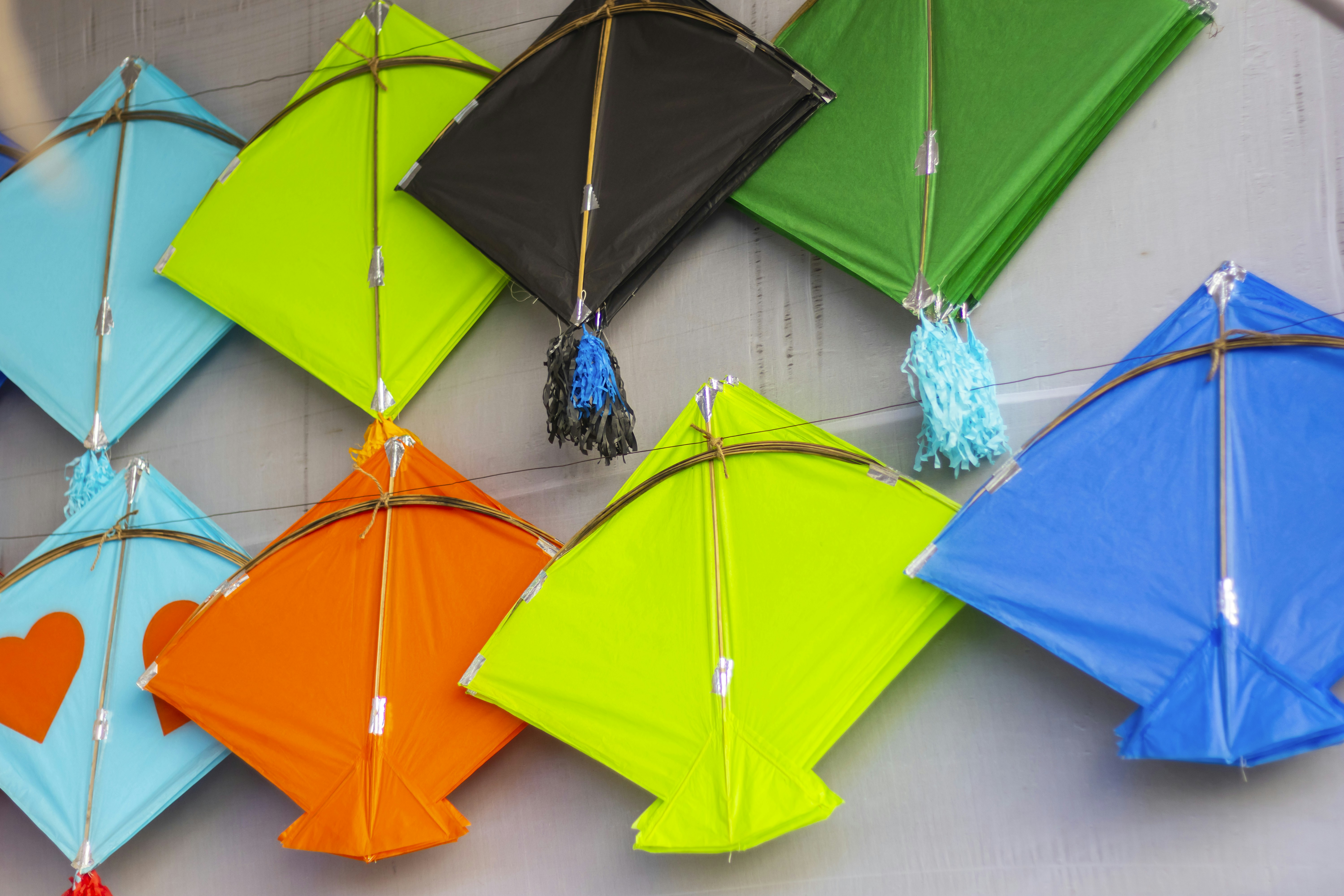 A group of colorful kites hanging on a wall photo – Free India Image on ...
